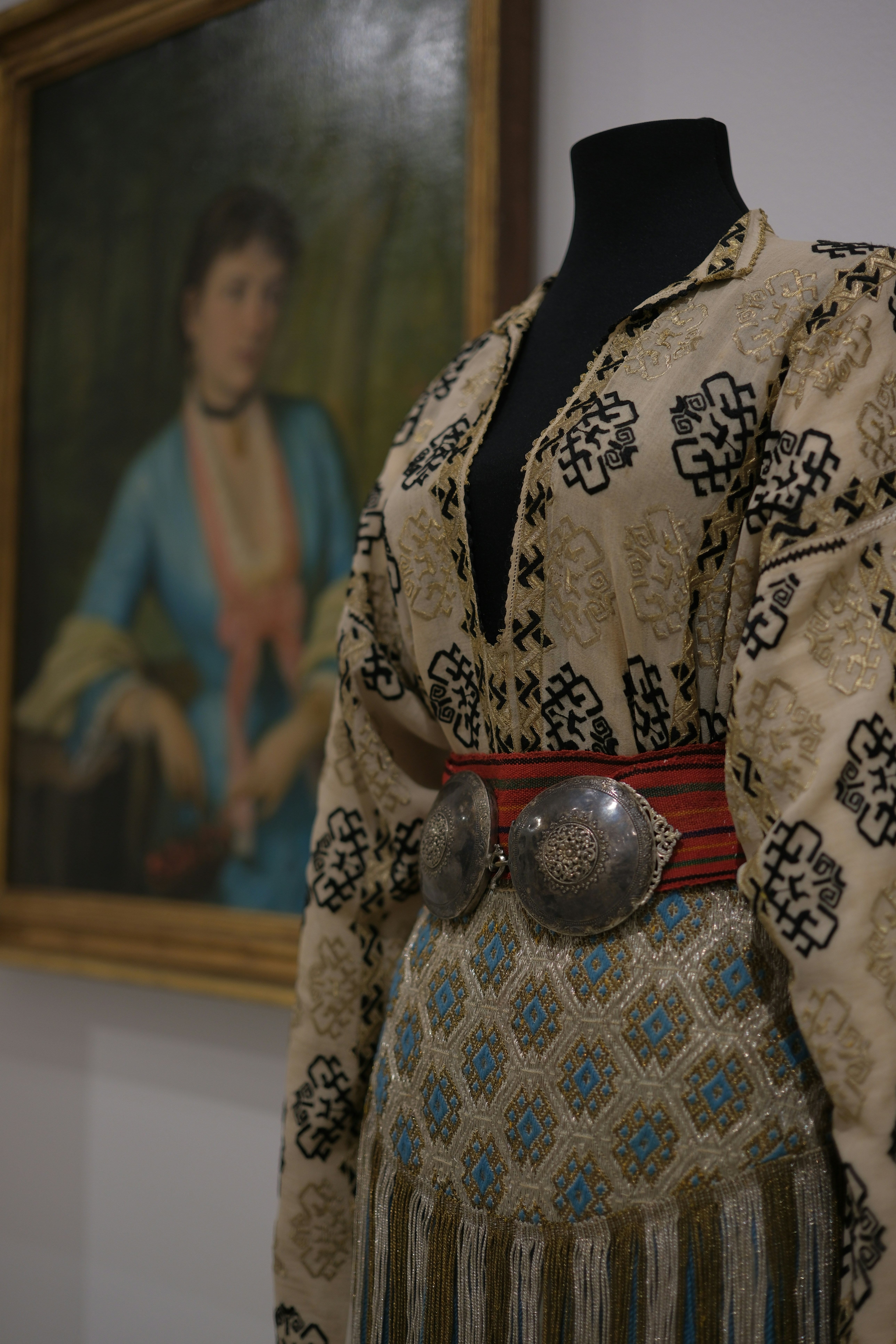 Ornate Silhouette: Silk Dress with Silver Buckles on Display