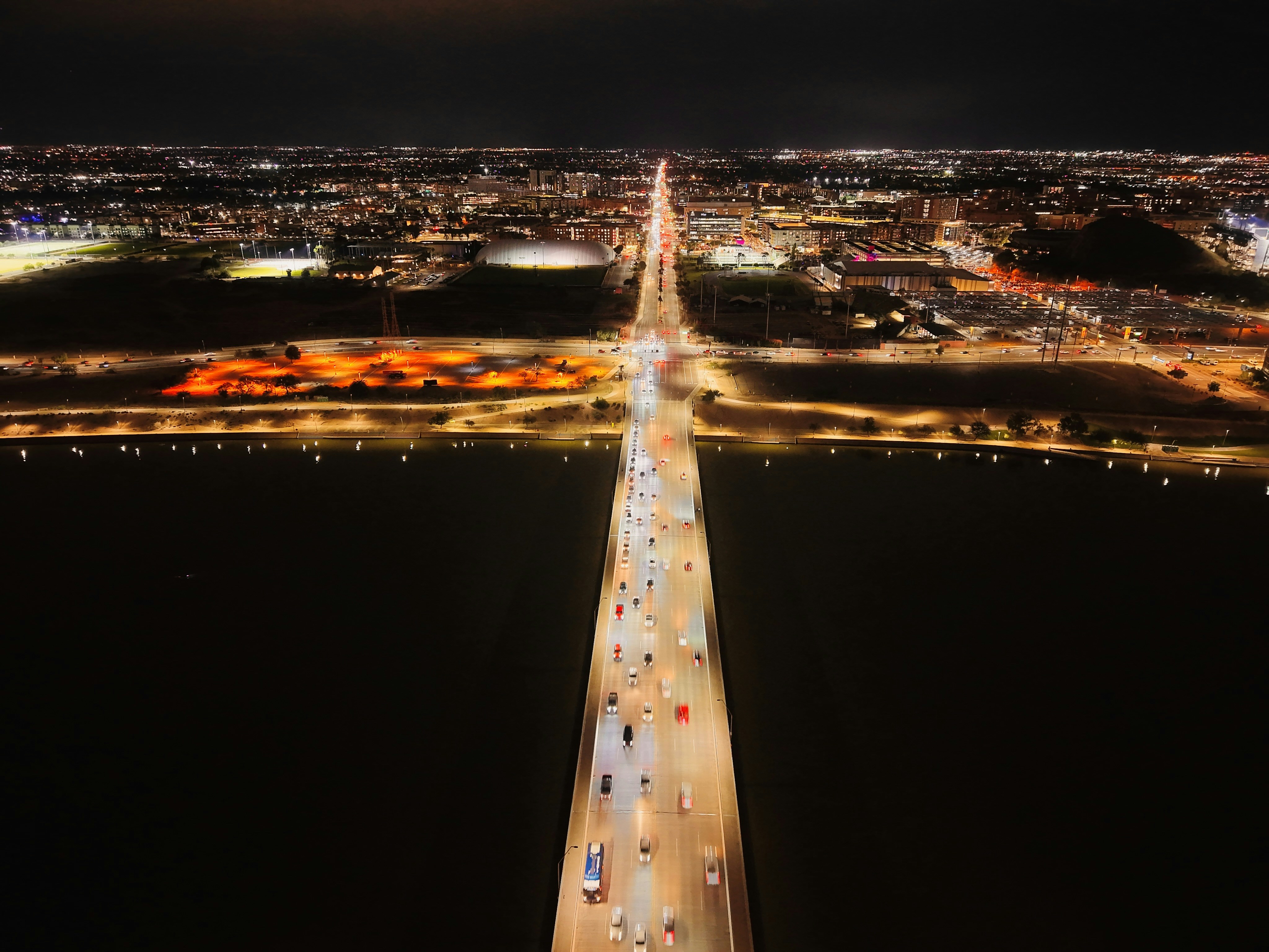 Midnight arterial glow: a central avenue slicing through a sleeping city