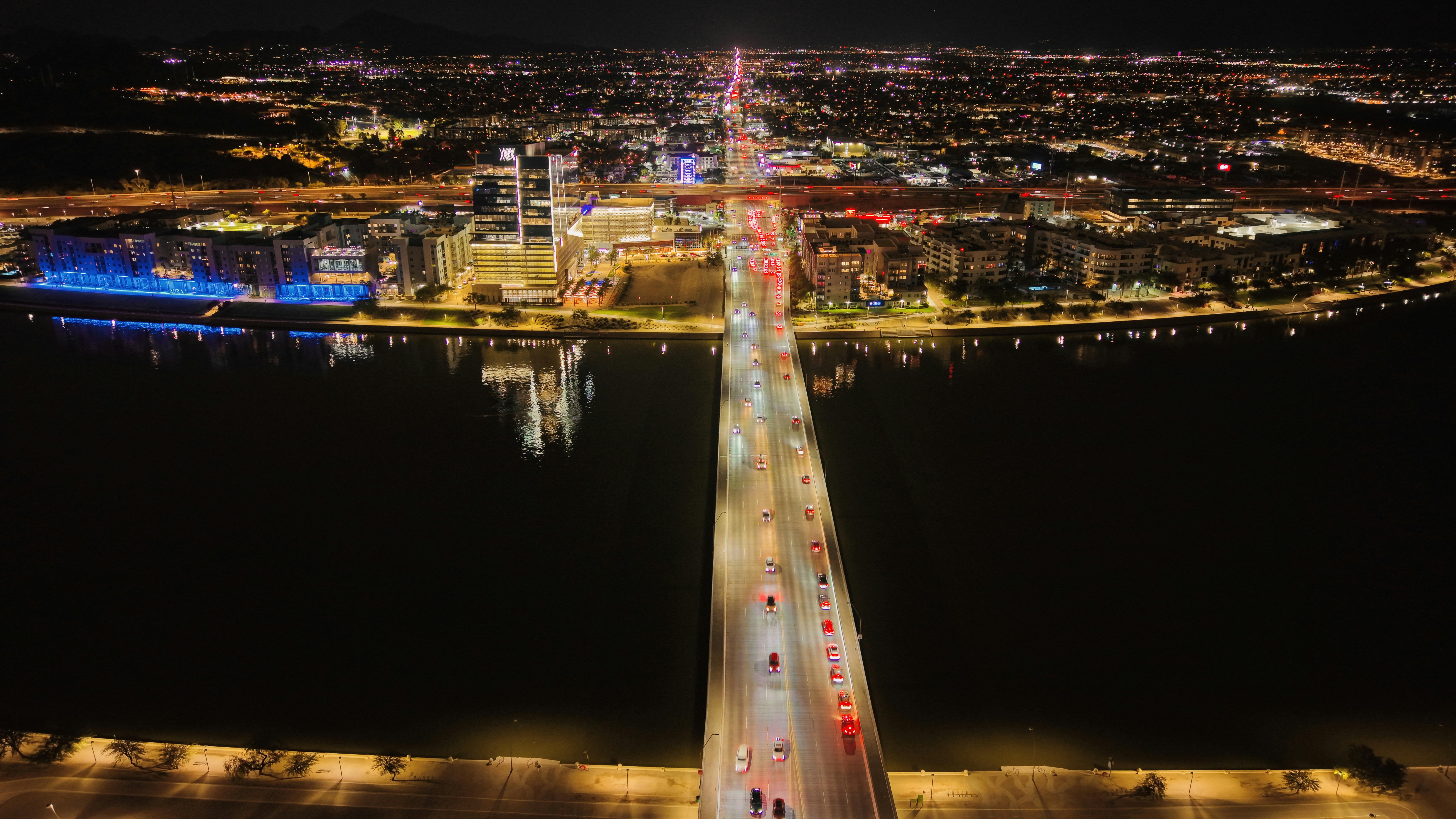 Cityscape with bridge and river at night