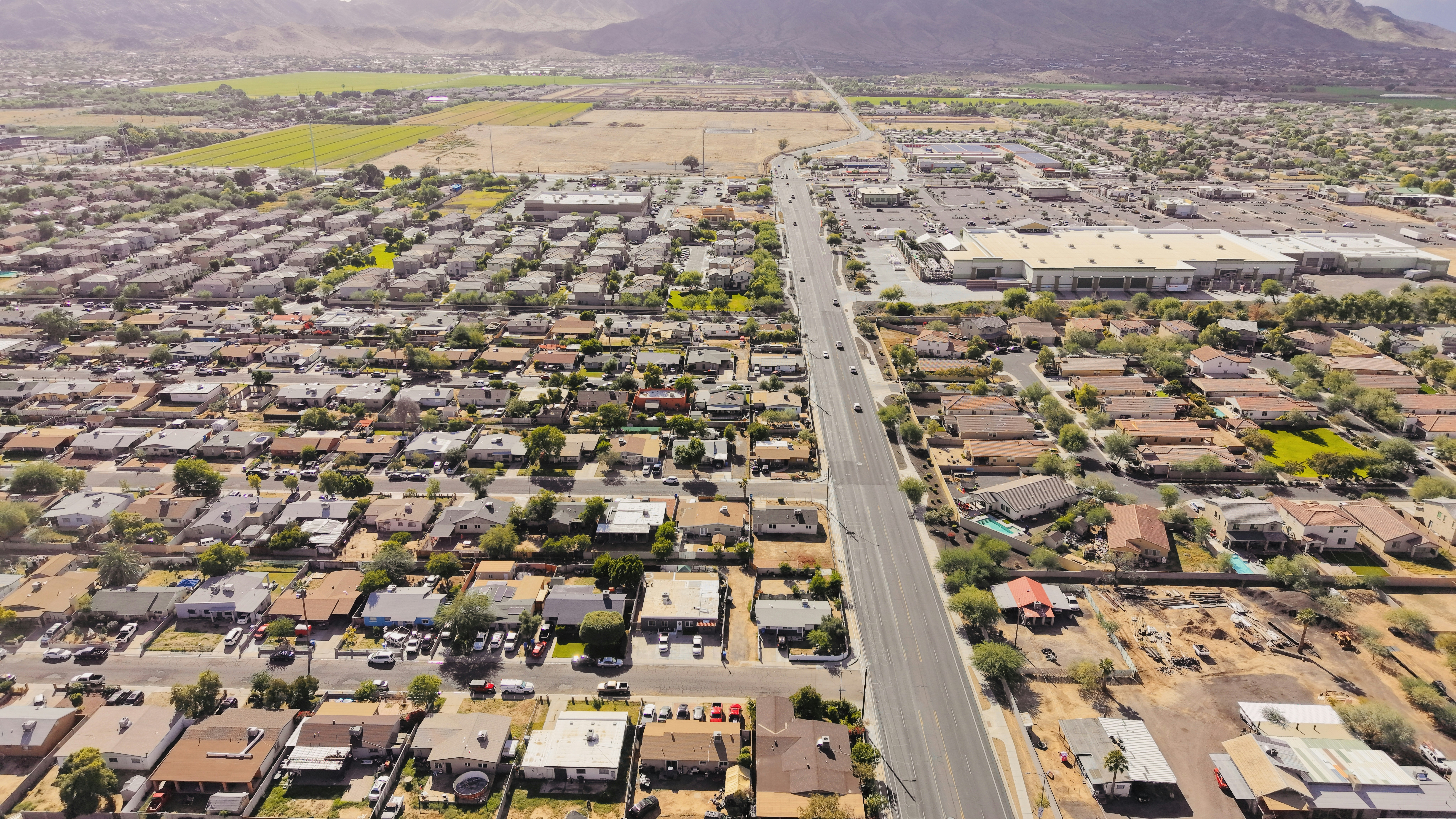 Aerial view of suburban neighborhood with a long road.