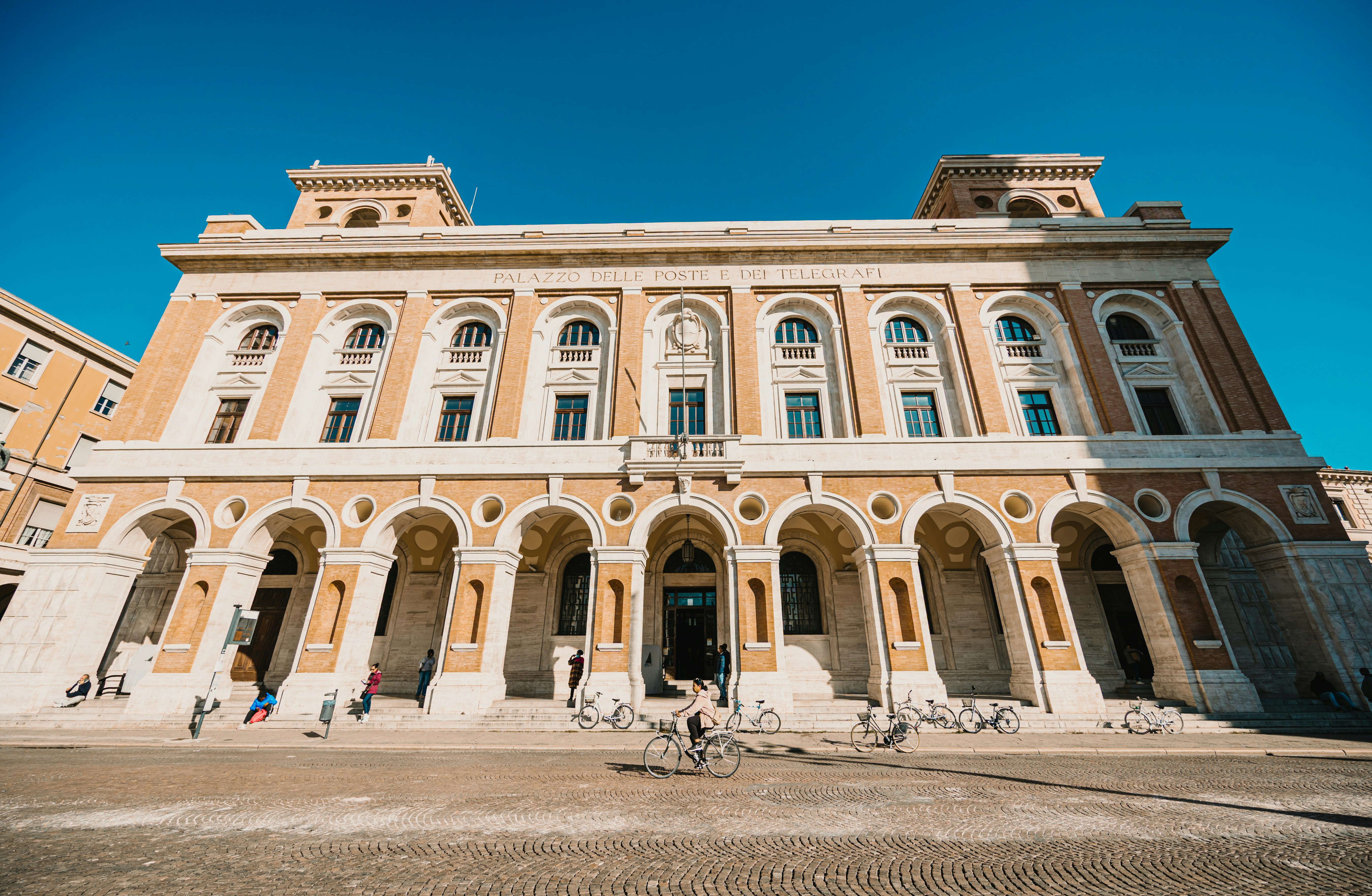Sunlit Arcades: Symmetry of a Campus Facade Framed by Bicycles