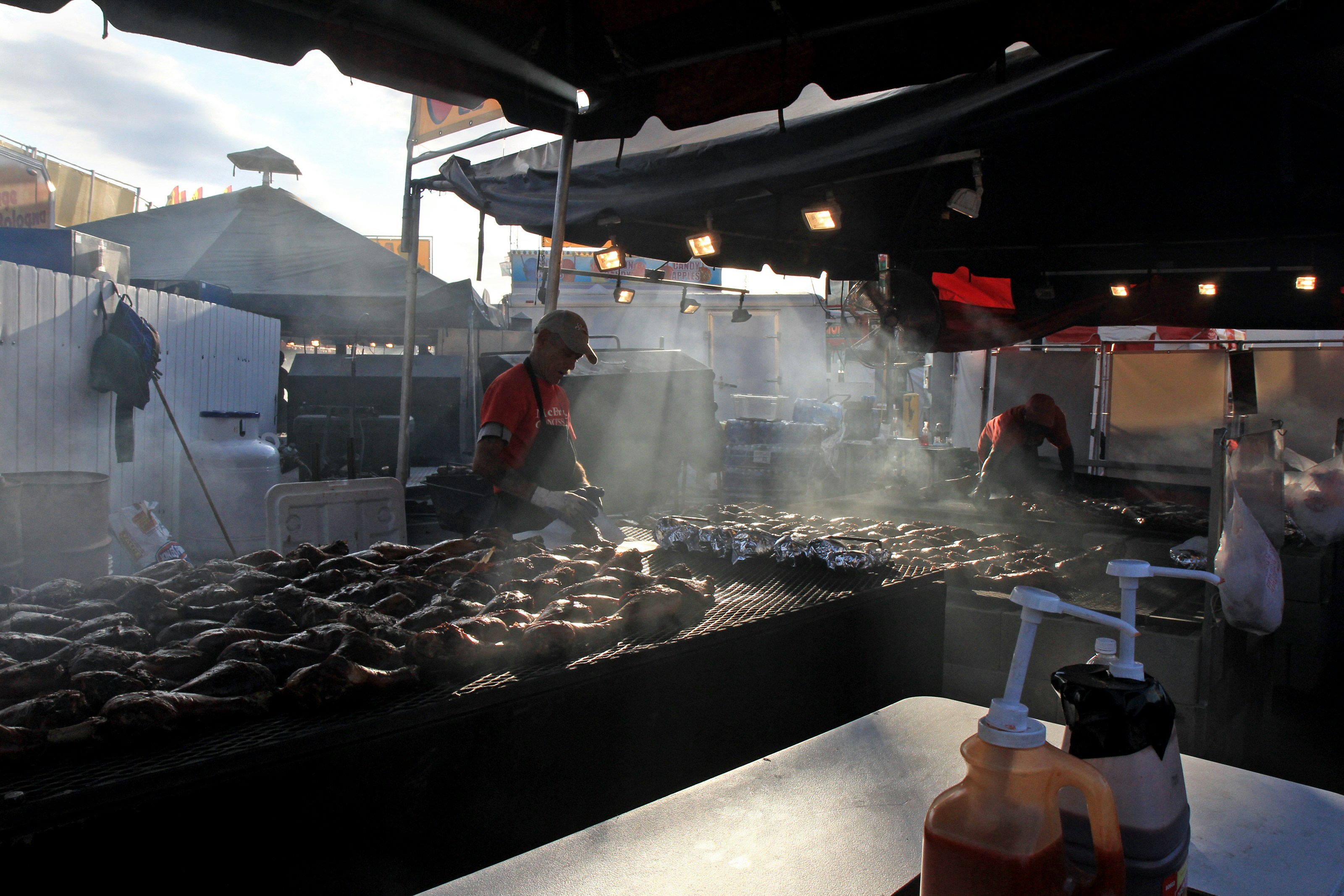 "Turkey Leg Vendor" --- The smoky environs of a turkey leg vendor at a state fair.