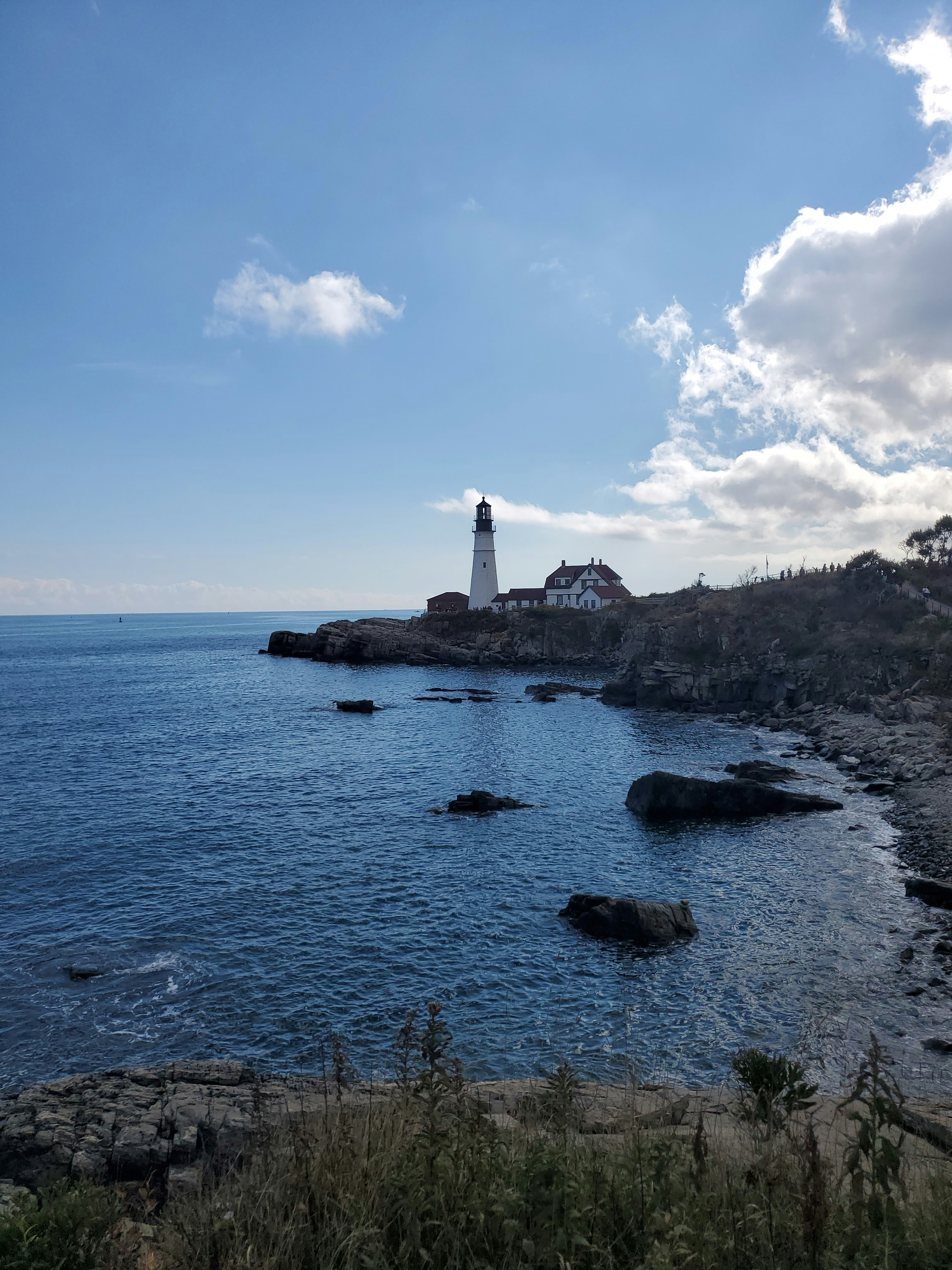 Beacon on the Edge: Lighthouse Framed by Quiet Atlantic Blues