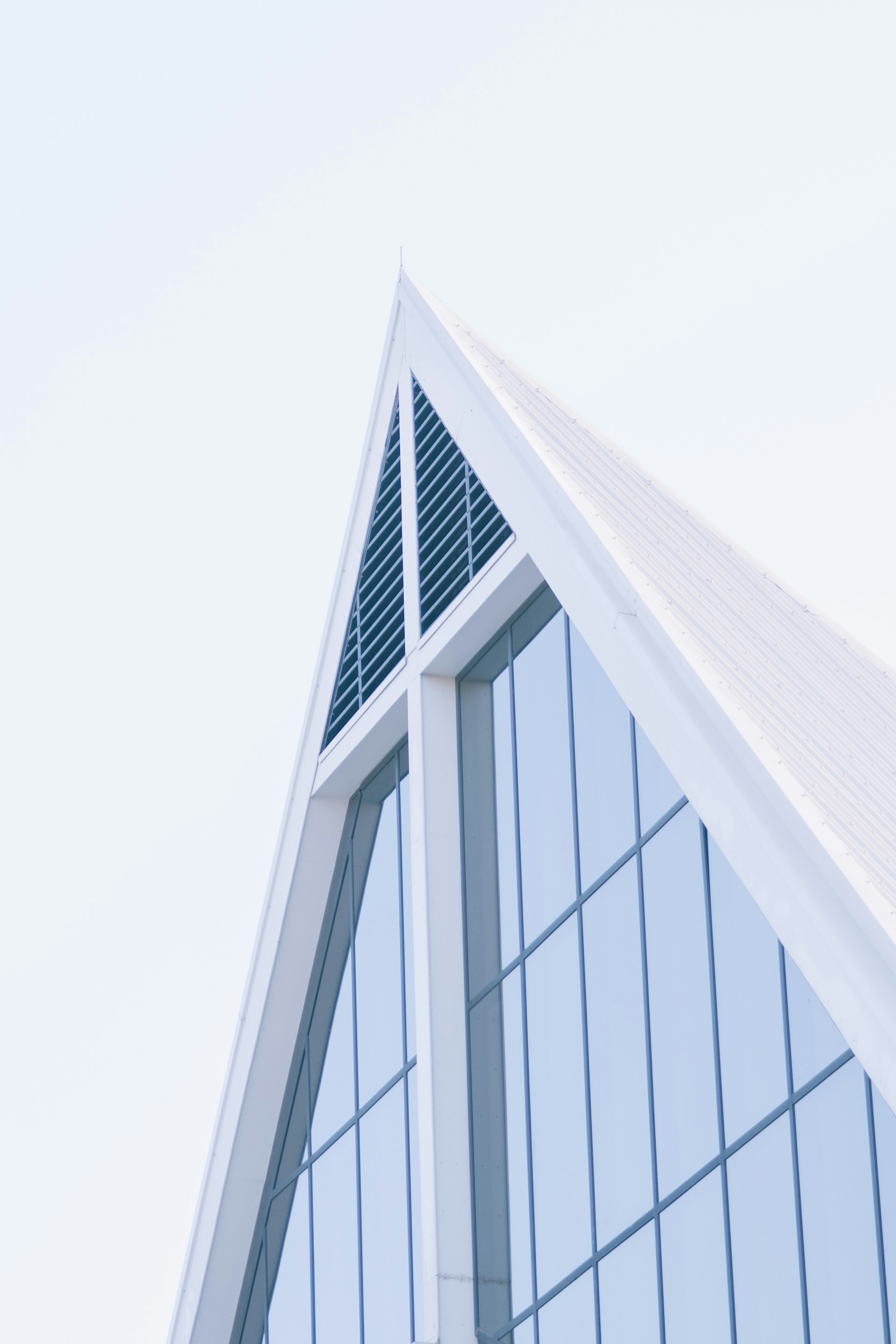 Modern triangular building with large glass windows photo – Free ...