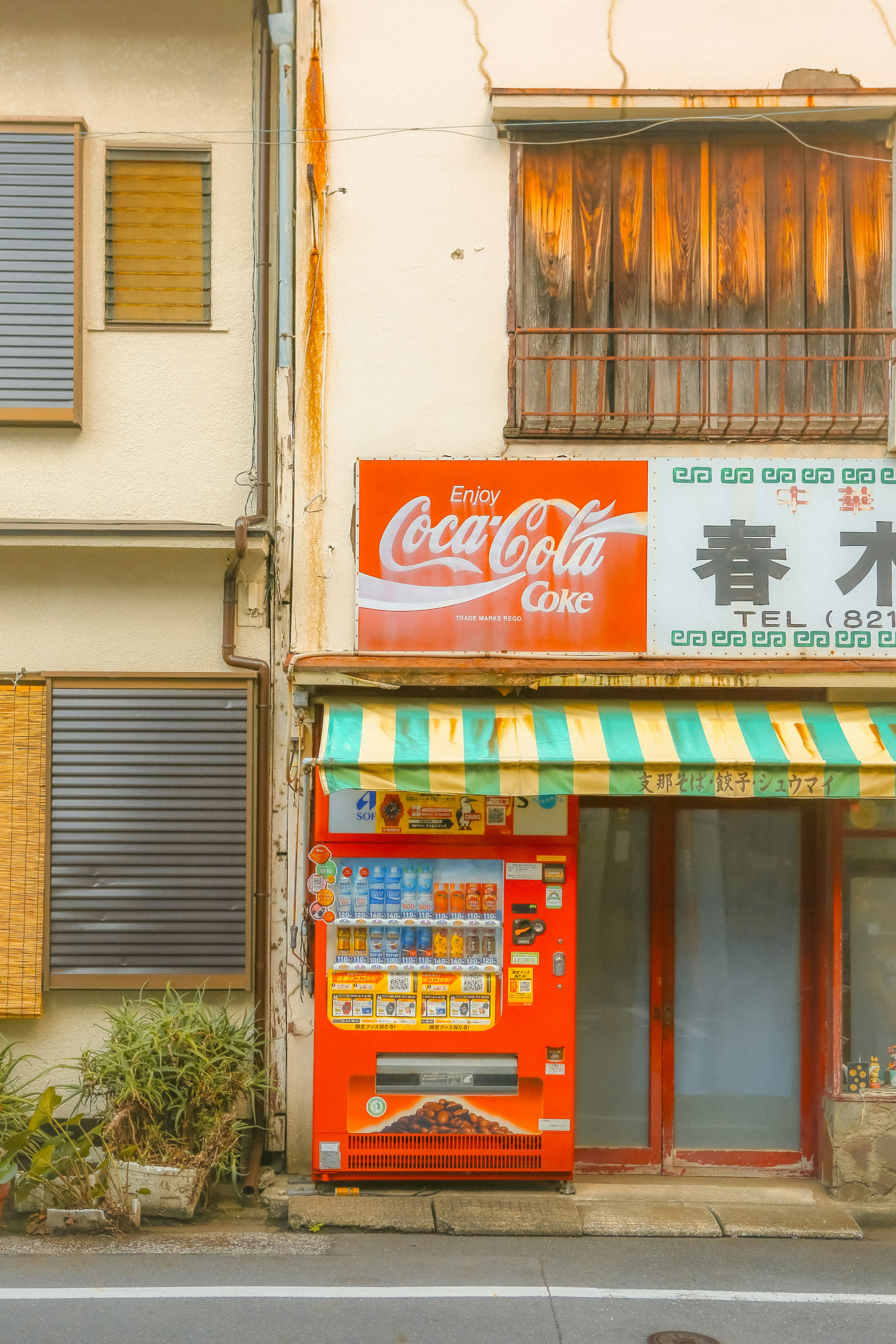 Red vending machine outside a store with coca-cola sign photo – Free ...