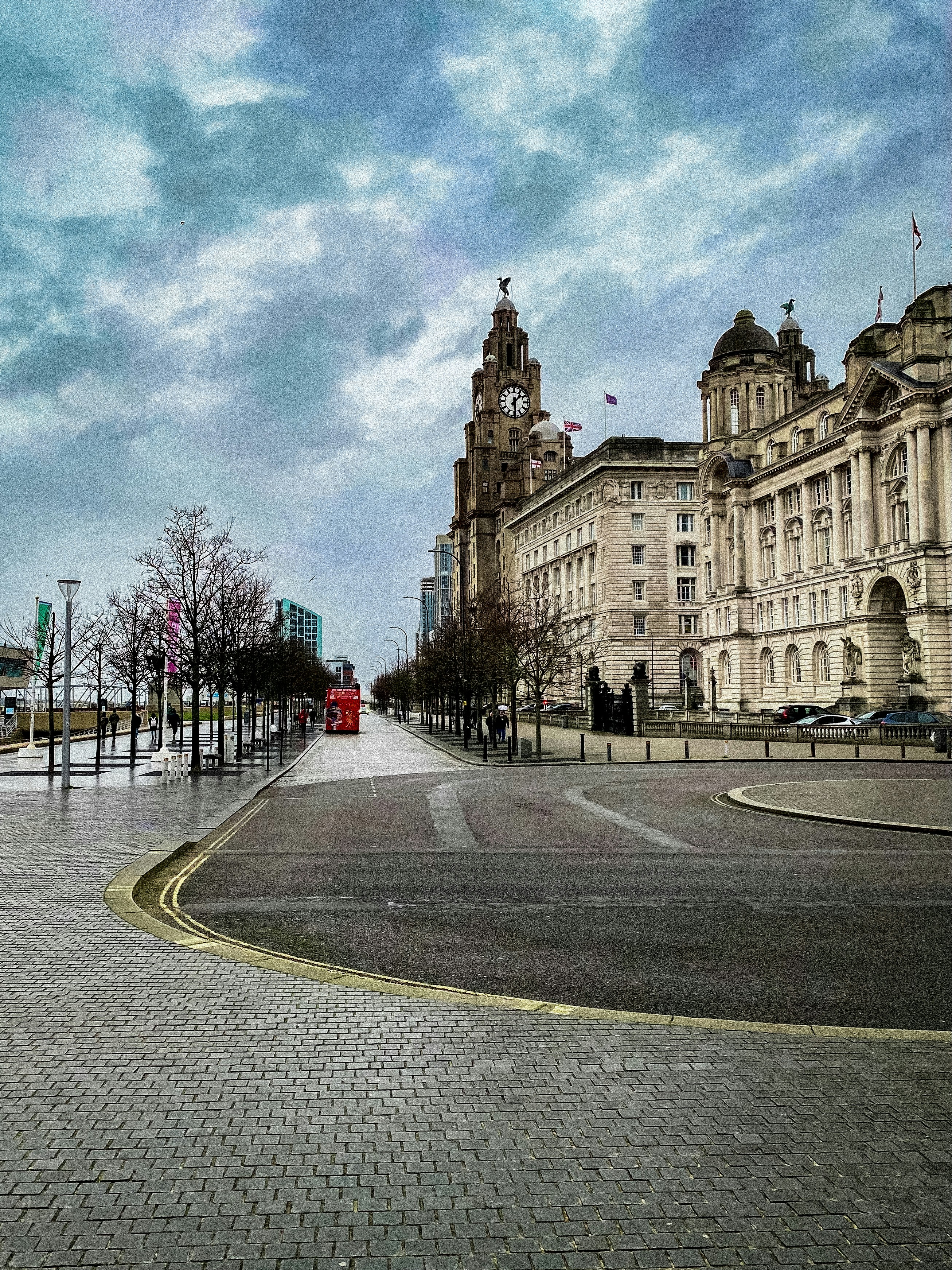 Red Bus on Liverpool’s Curved Esplanade: Clocktower and Stone Facades