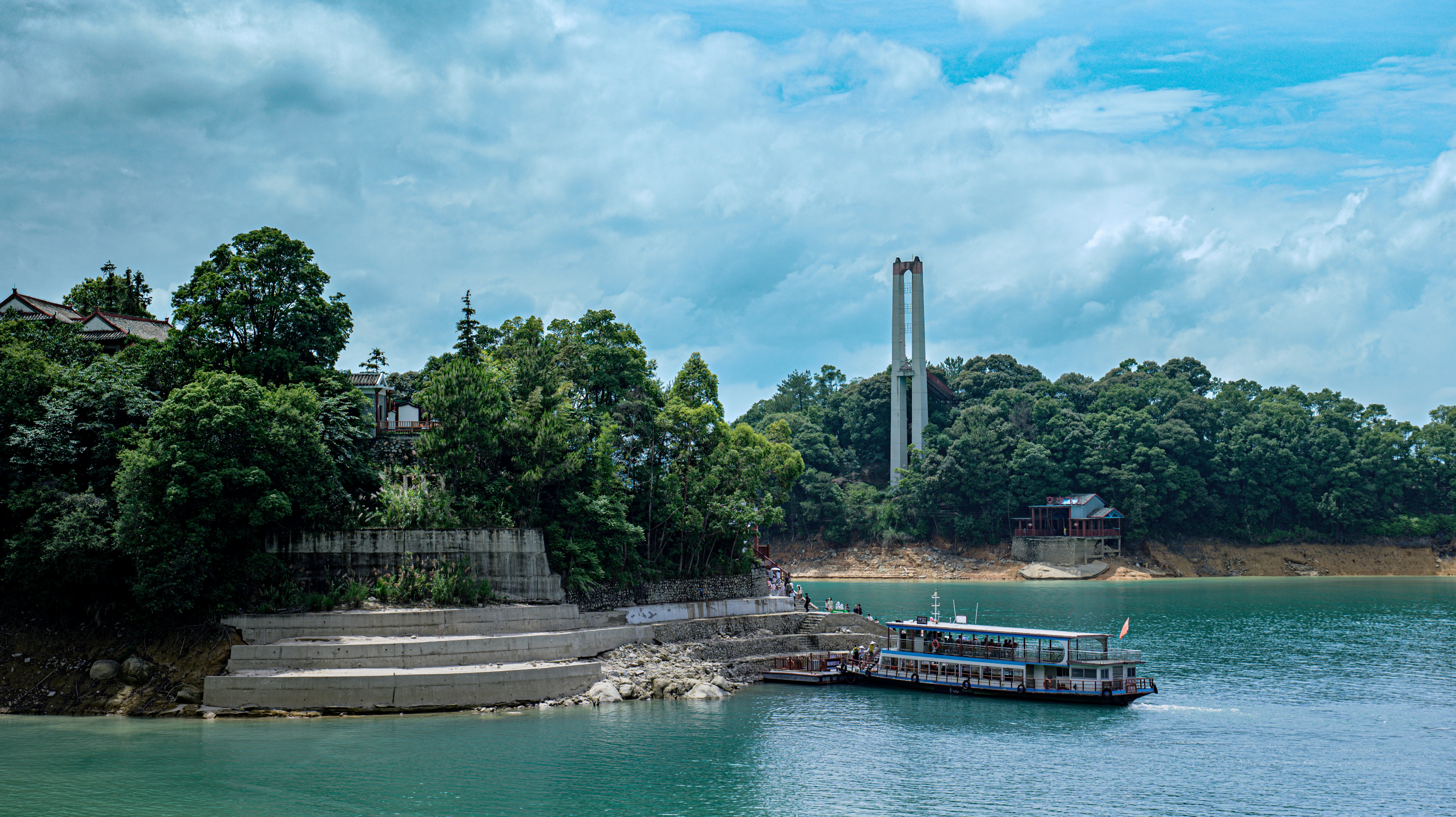 Tower over Turquoise Waters: A Quiet Lakeside Wharf Scene