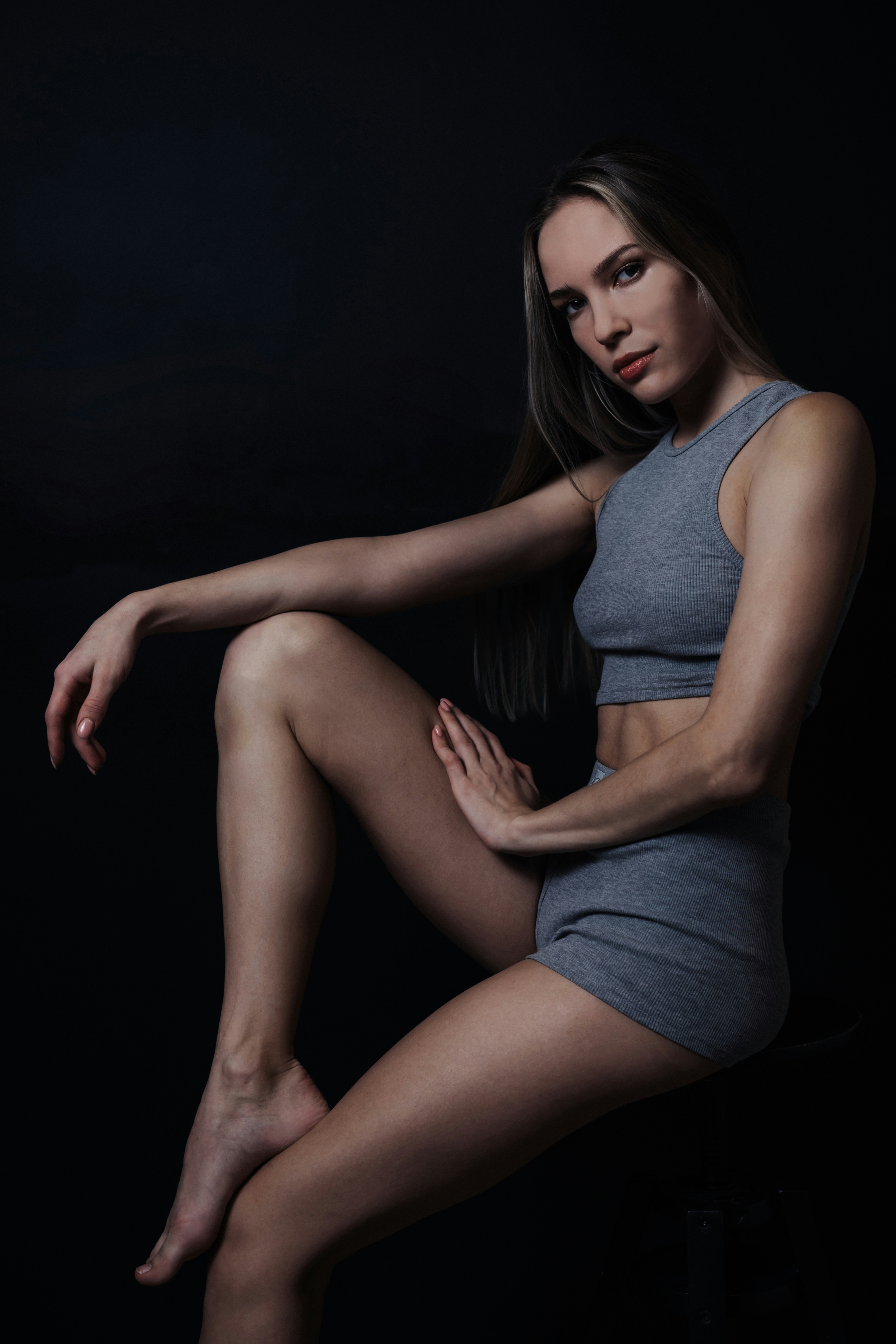 Shadowed Confidence: Studio Portrait in Gray Athleticwear