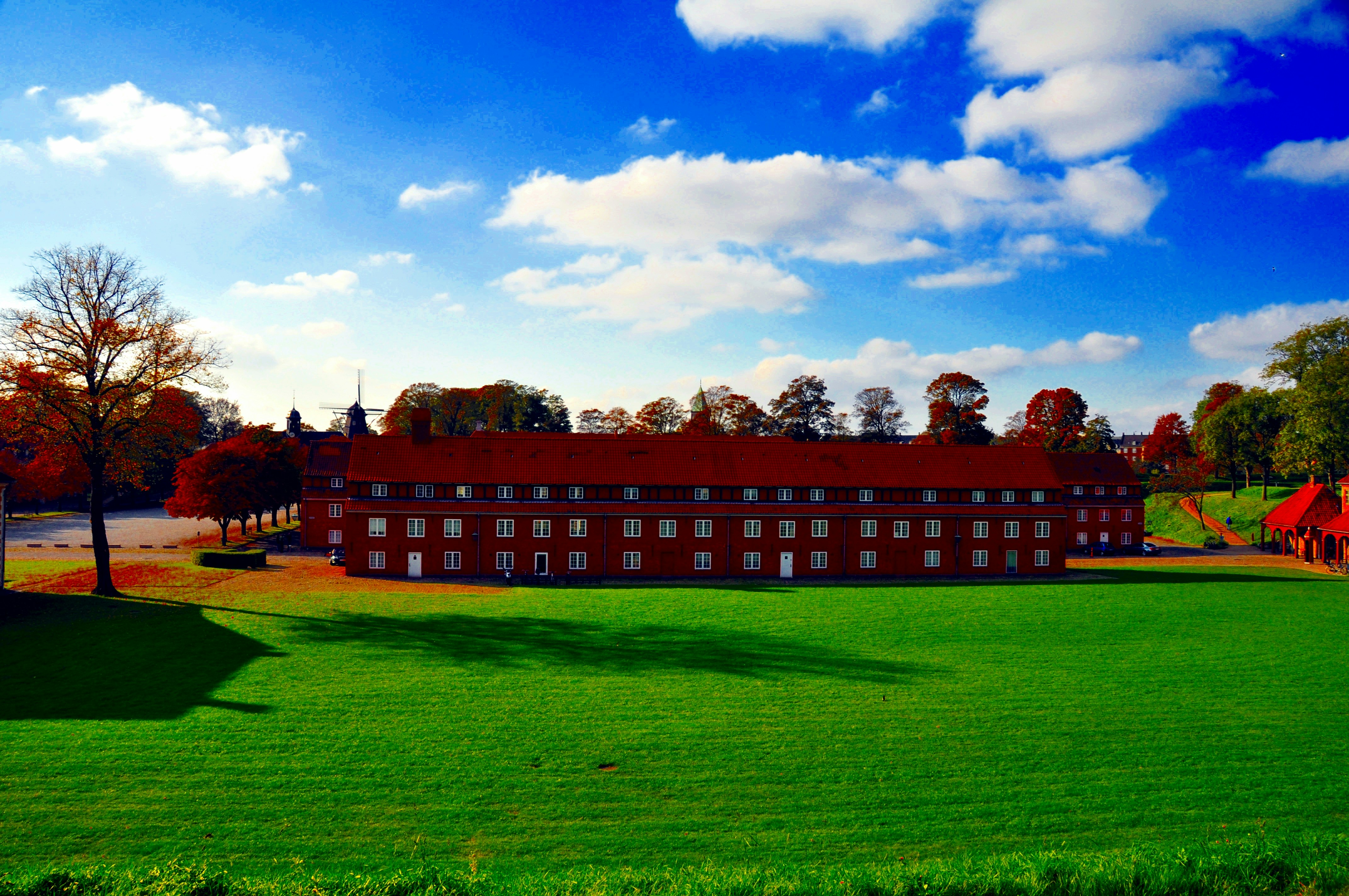 Red-Brick Manor on a Rolling Green Canvas