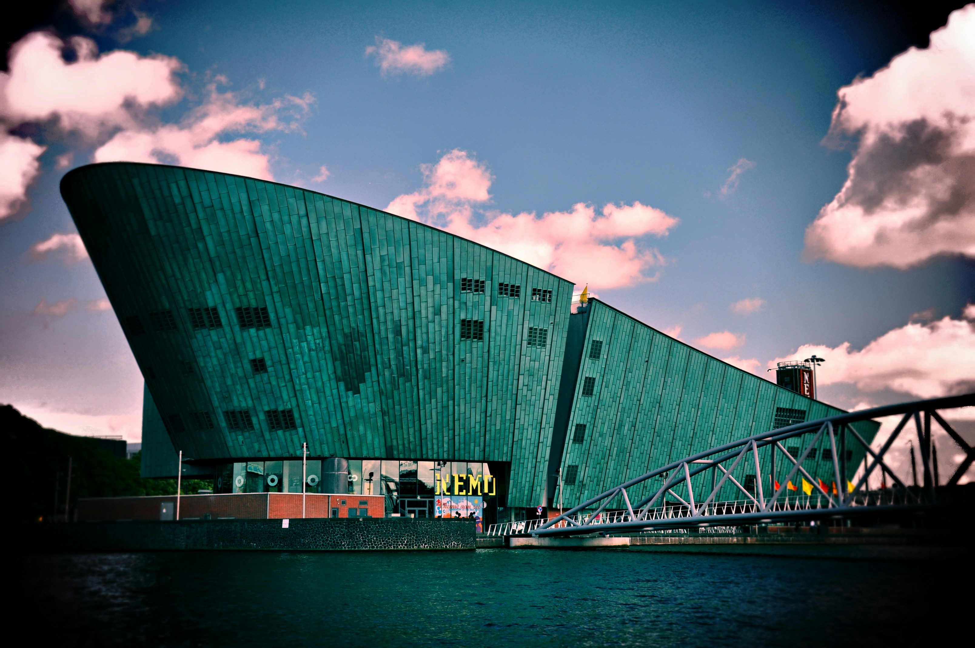 Teal Curves by the River: A Minimalist Waterfront Architecture Scene