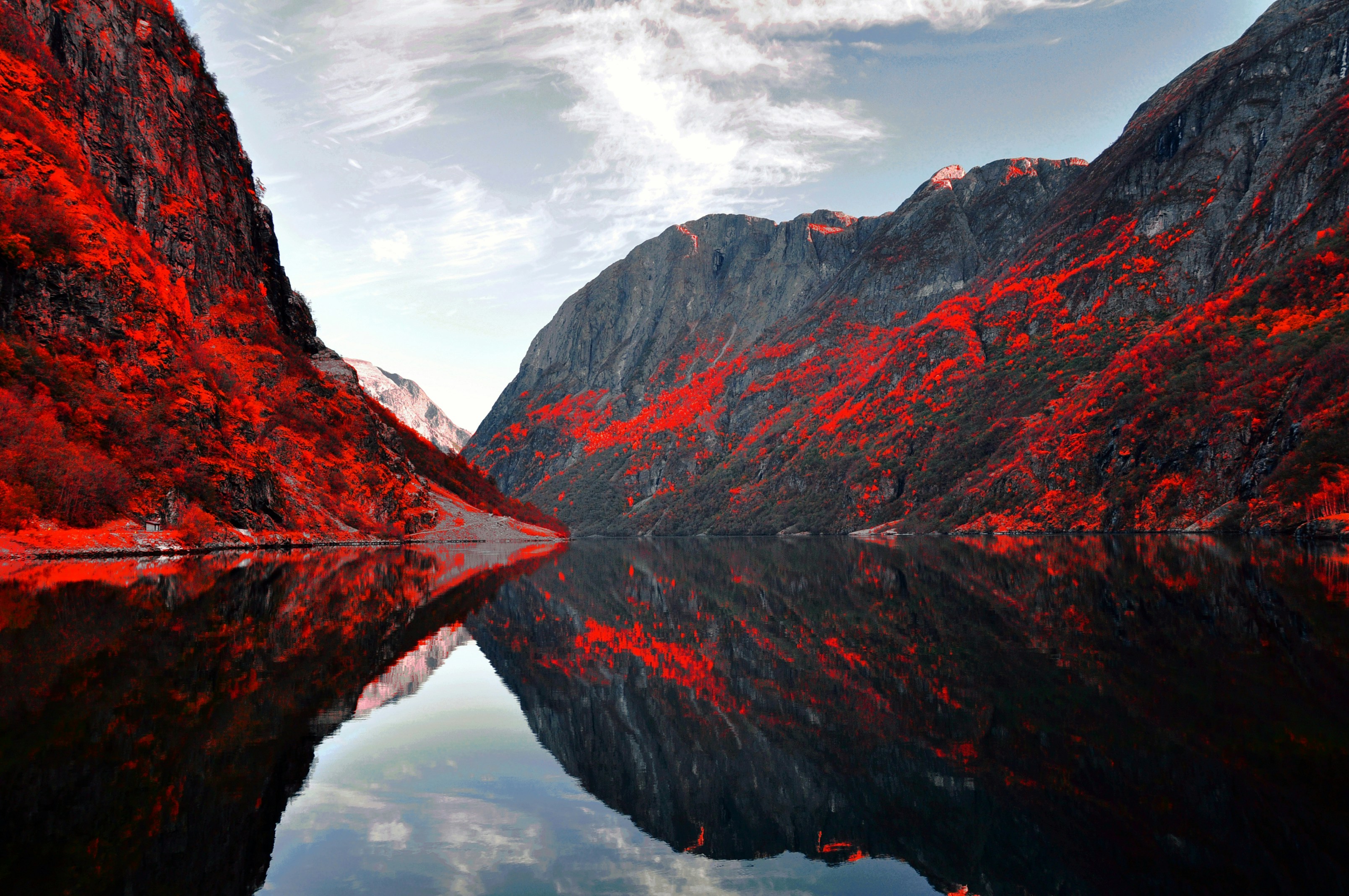 Crimson Fjord Reflections: Red Peaks and a Mirror Lake