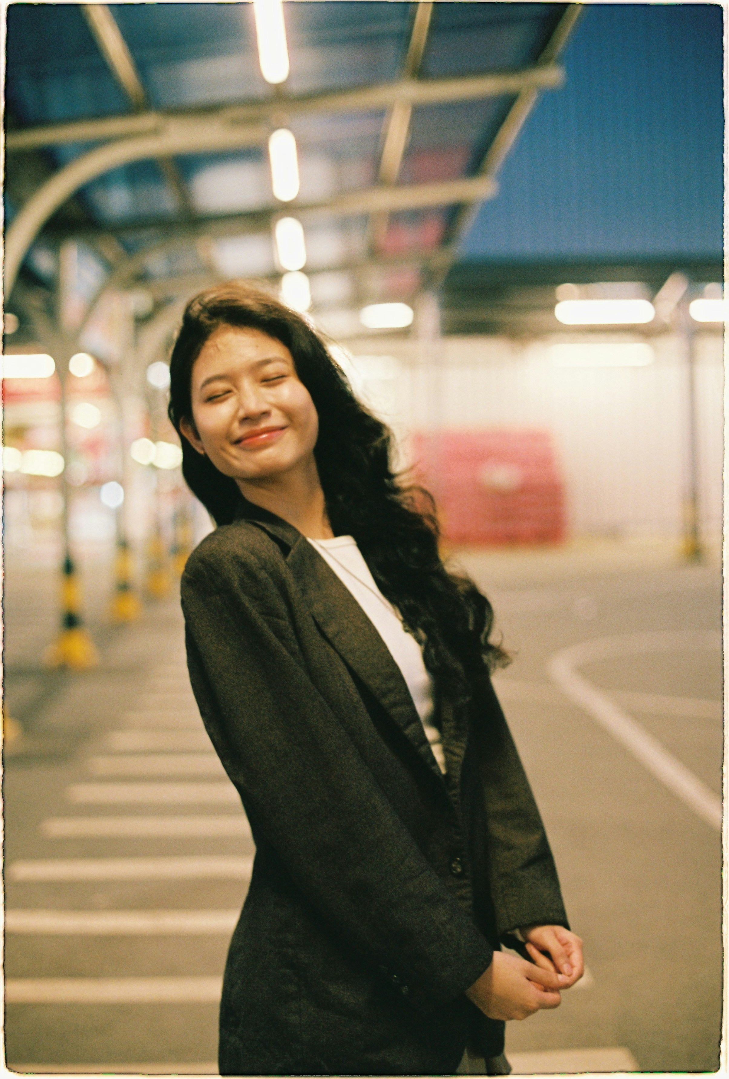 Neon Quiet: Portrait Under the Transit Hall's Warm Glow