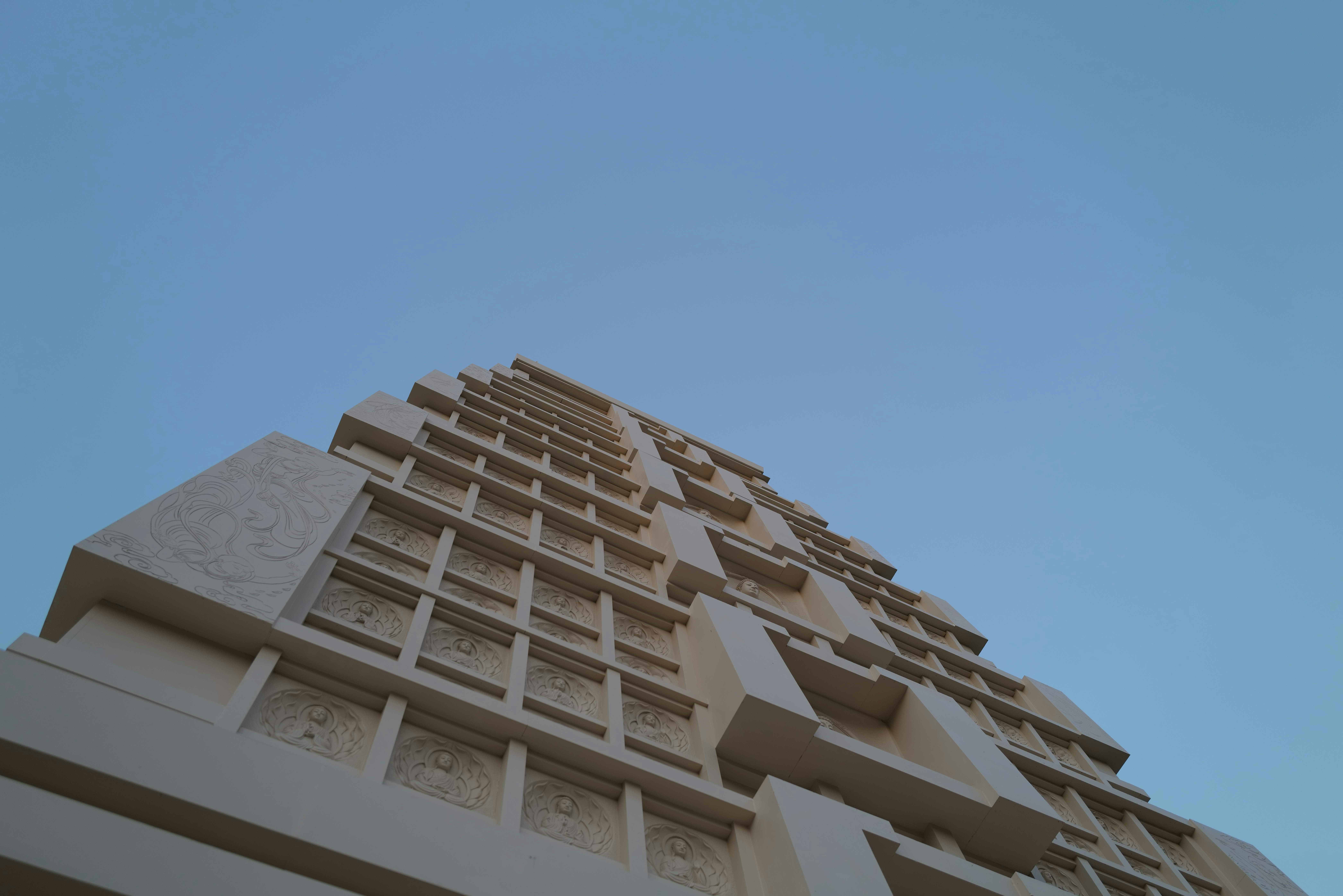 Ascending Geometry: A Tilted Concrete Facade Reaching for the Sky
