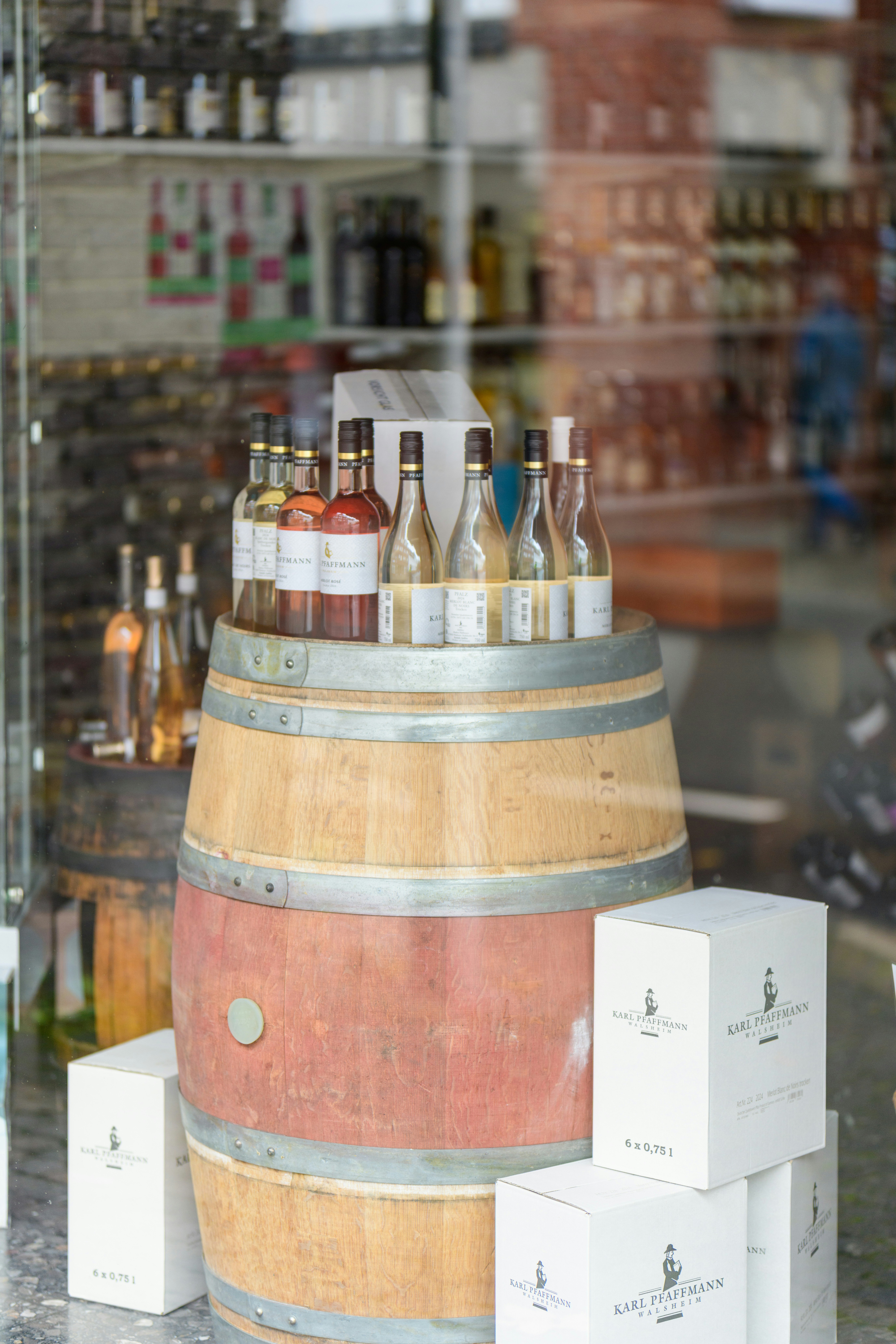 Barrel-Top Bottles in a Window Display: Reflections and Quiet Detail