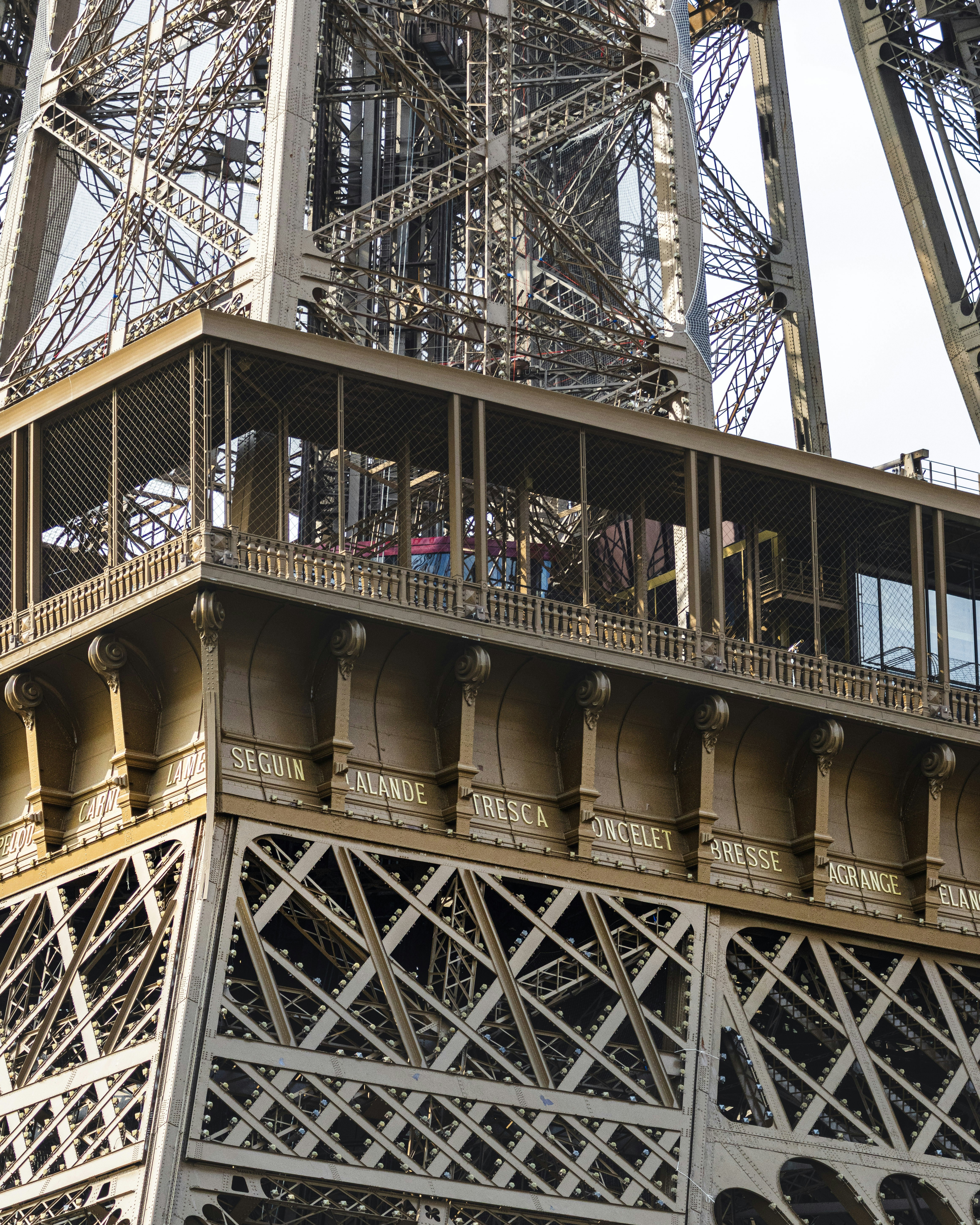 Crosshatched Majesty: Visitors on the Eiffel Tower's Lattice Balcony