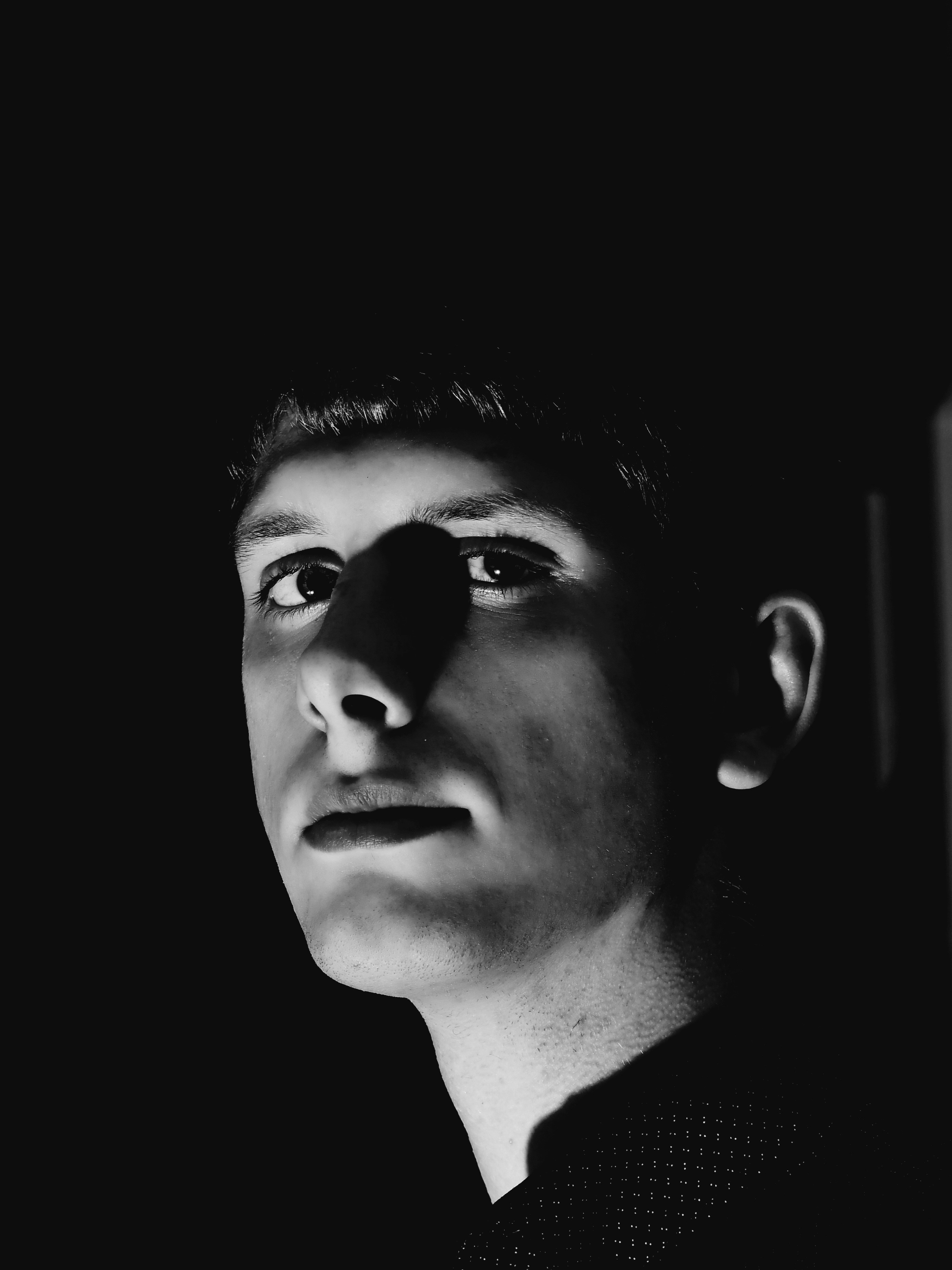 Chiaroscuro Gaze: Left-Lit Portrait of Quiet Resolve