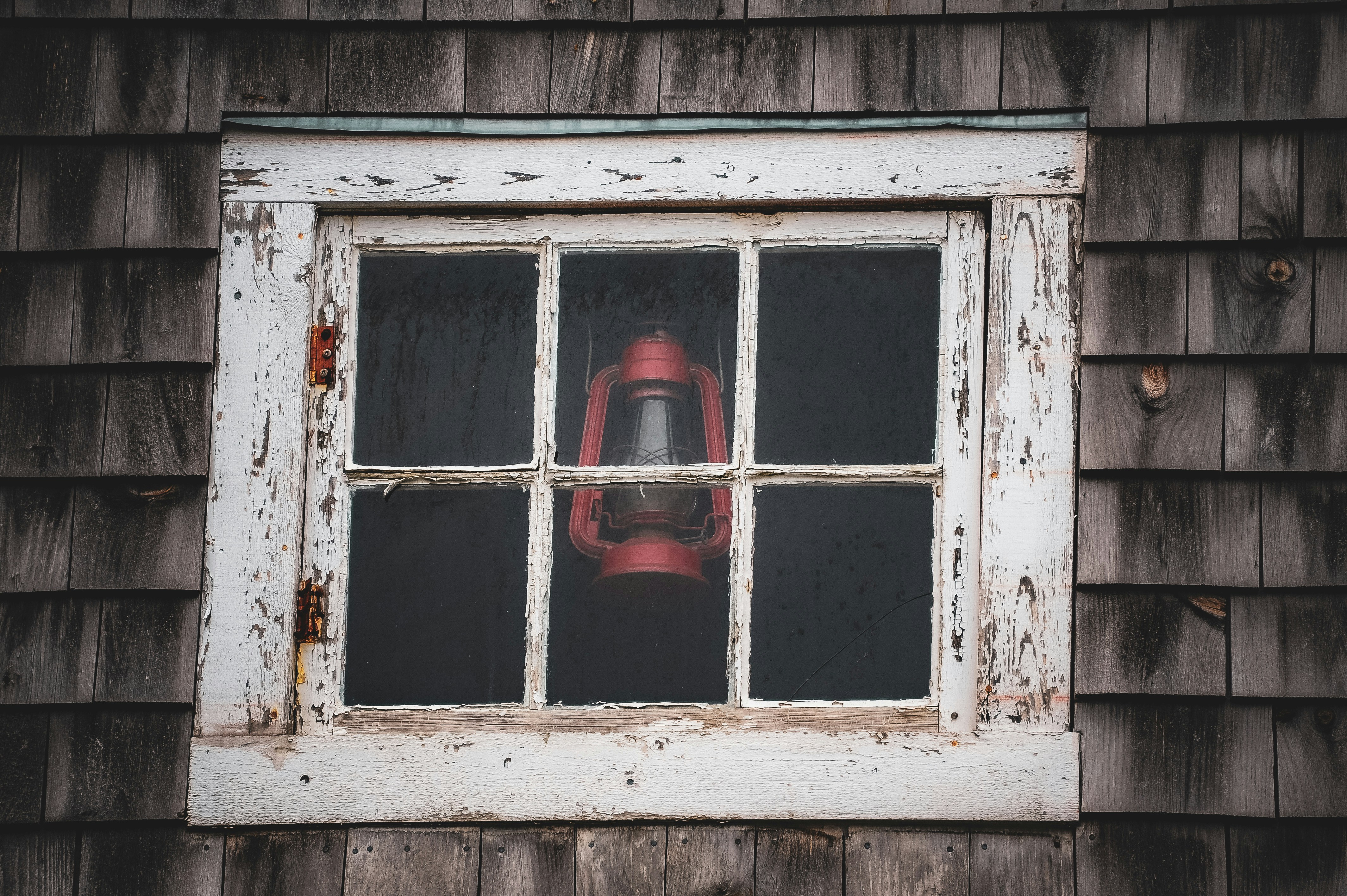 Red Lantern at a Weathered Window: A Quiet Threshold