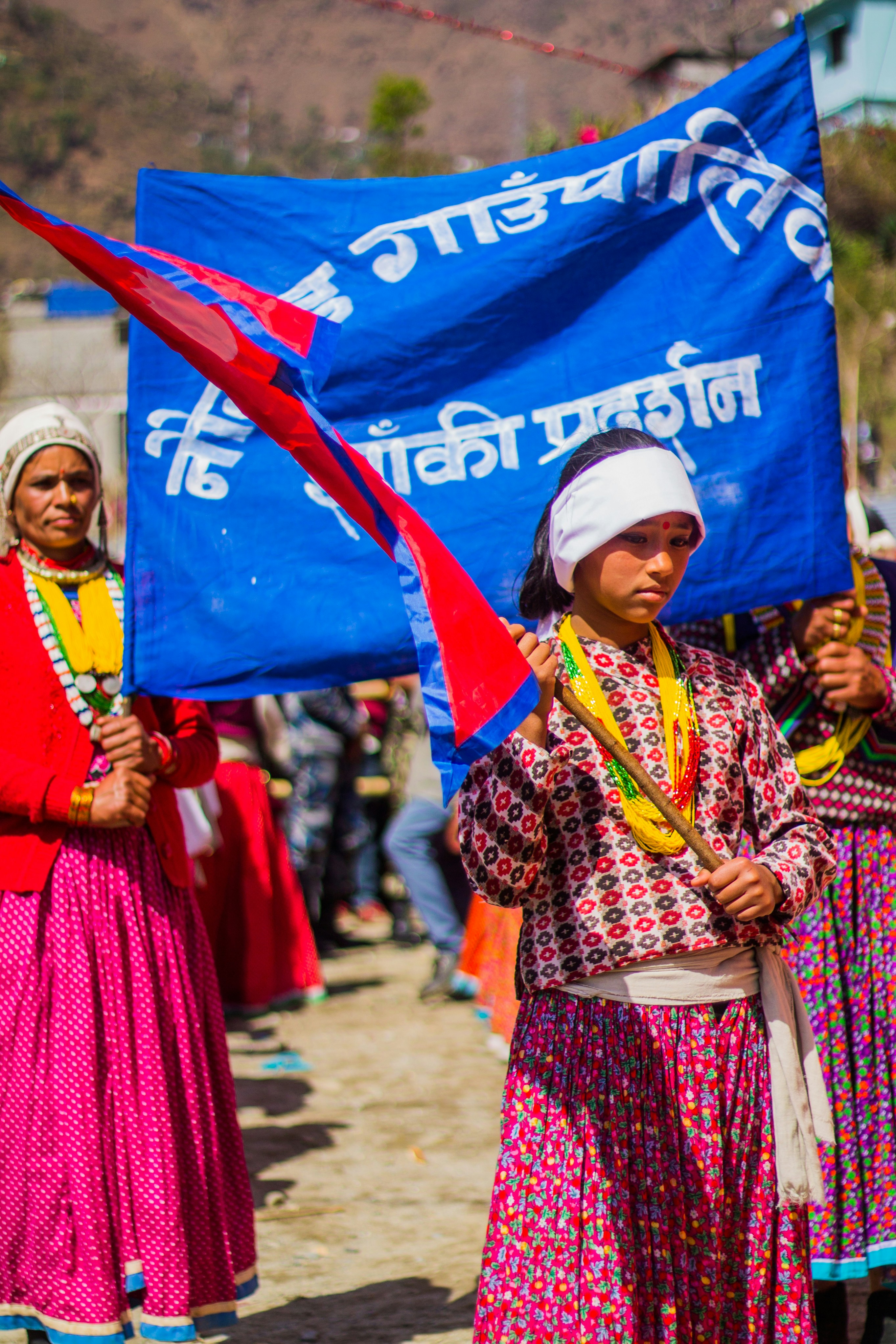 Bright Threads Under a Cerulean Banner: A Nepali Festival Moment