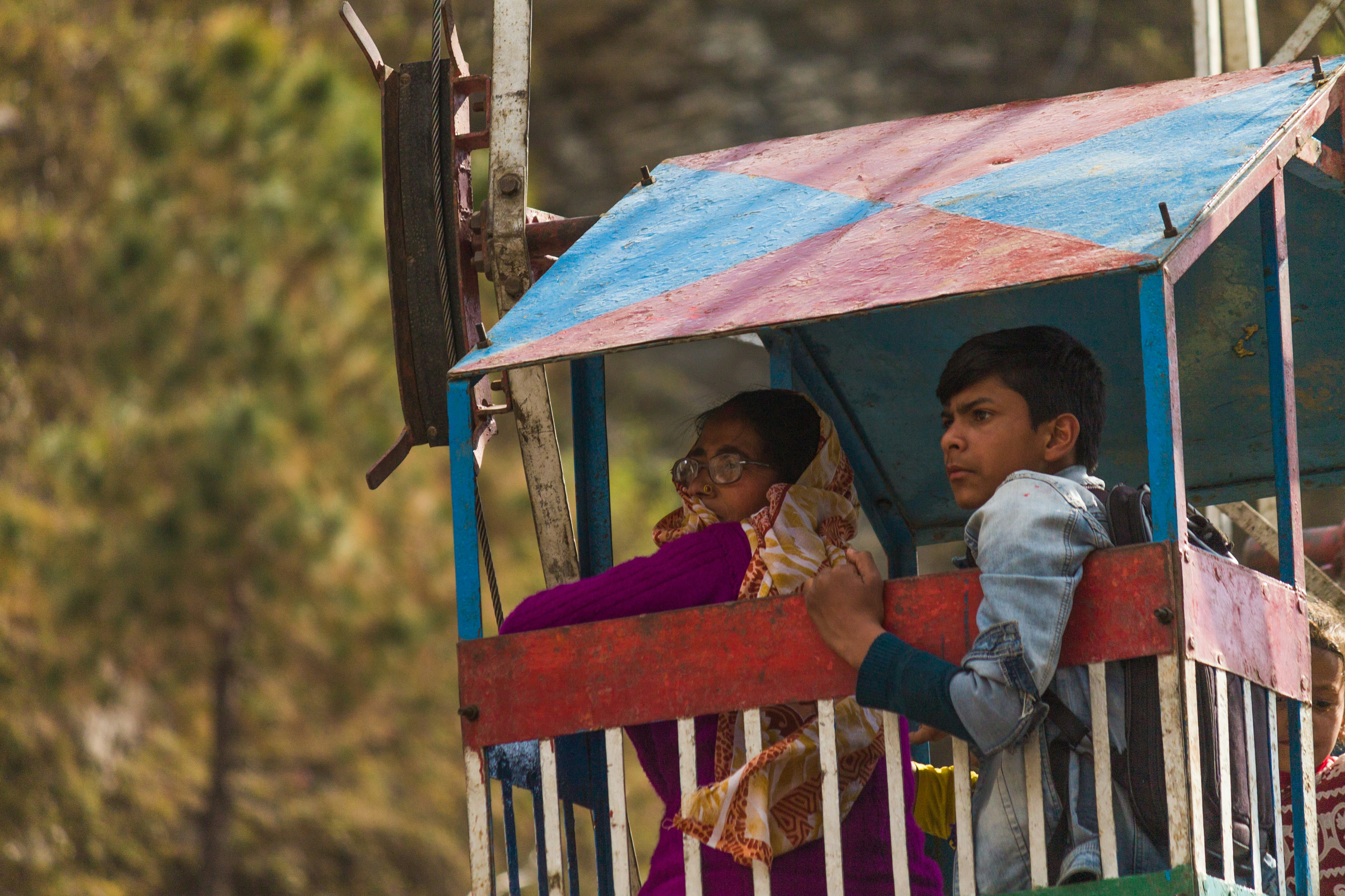 Two Curious Riders in a Rainbow-Colored Cart