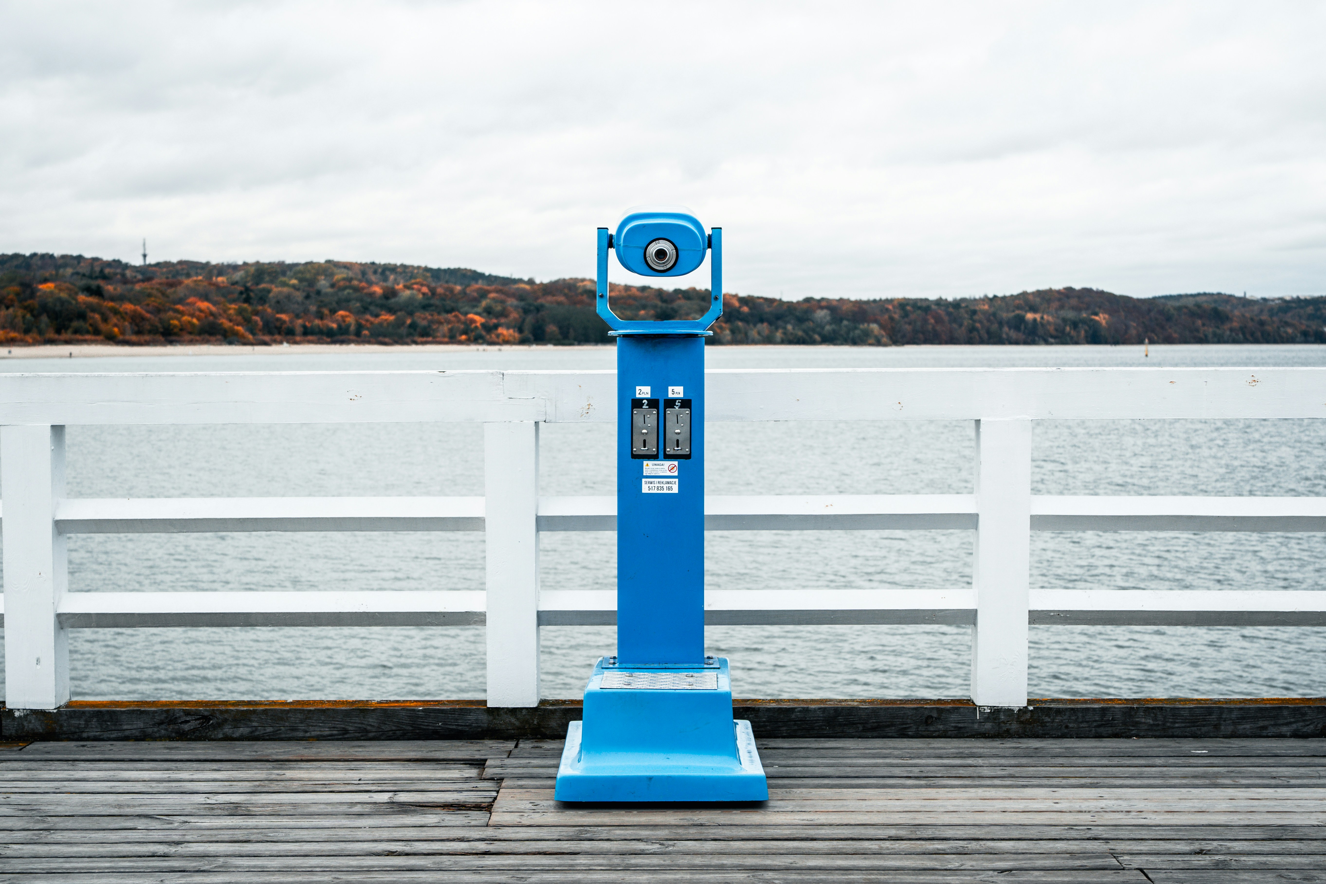 Azure Viewing Telescope Guards the Quiet Lakefront Pier