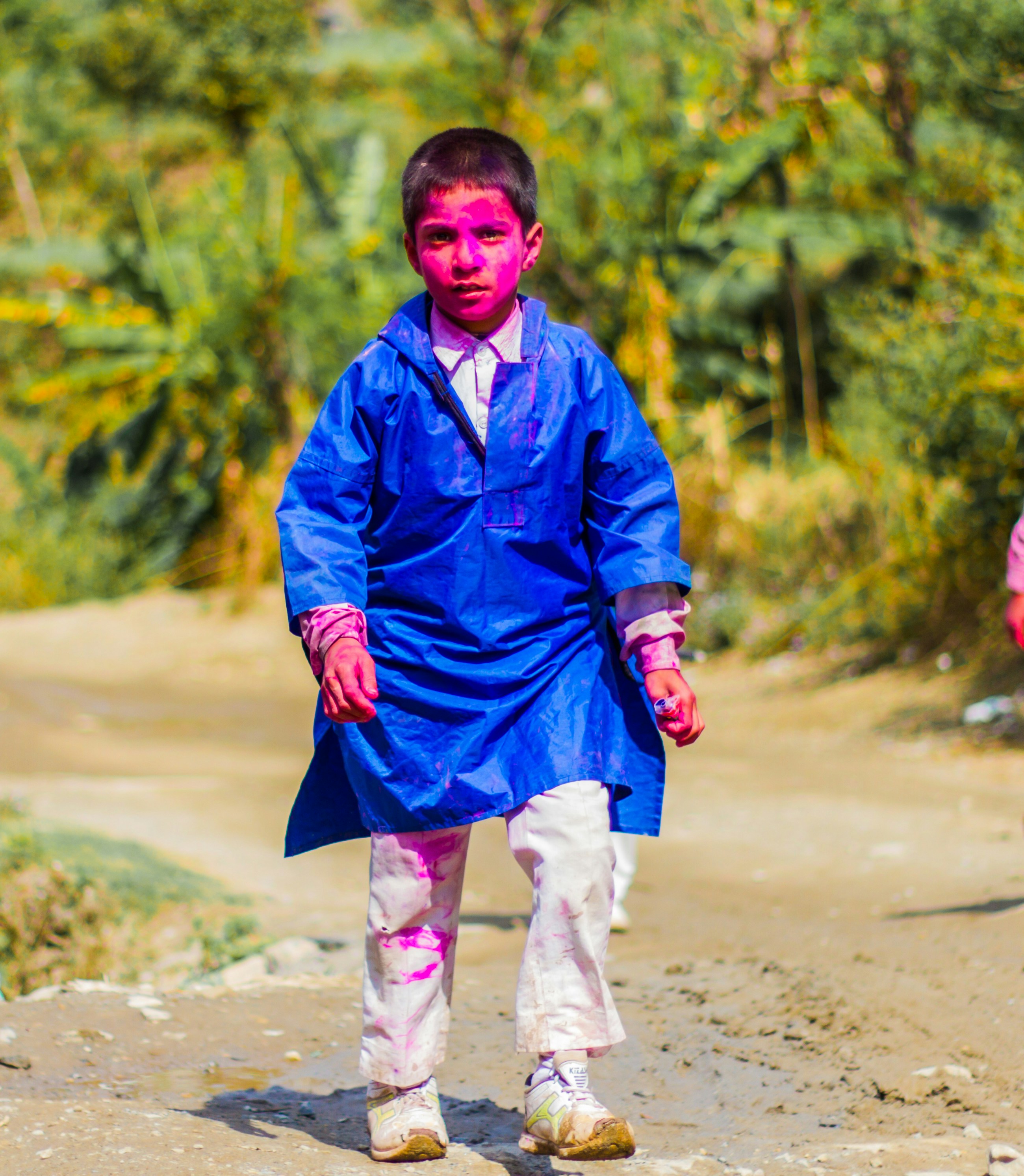 Blue-Garbed Youth Confronts a Dusty Path