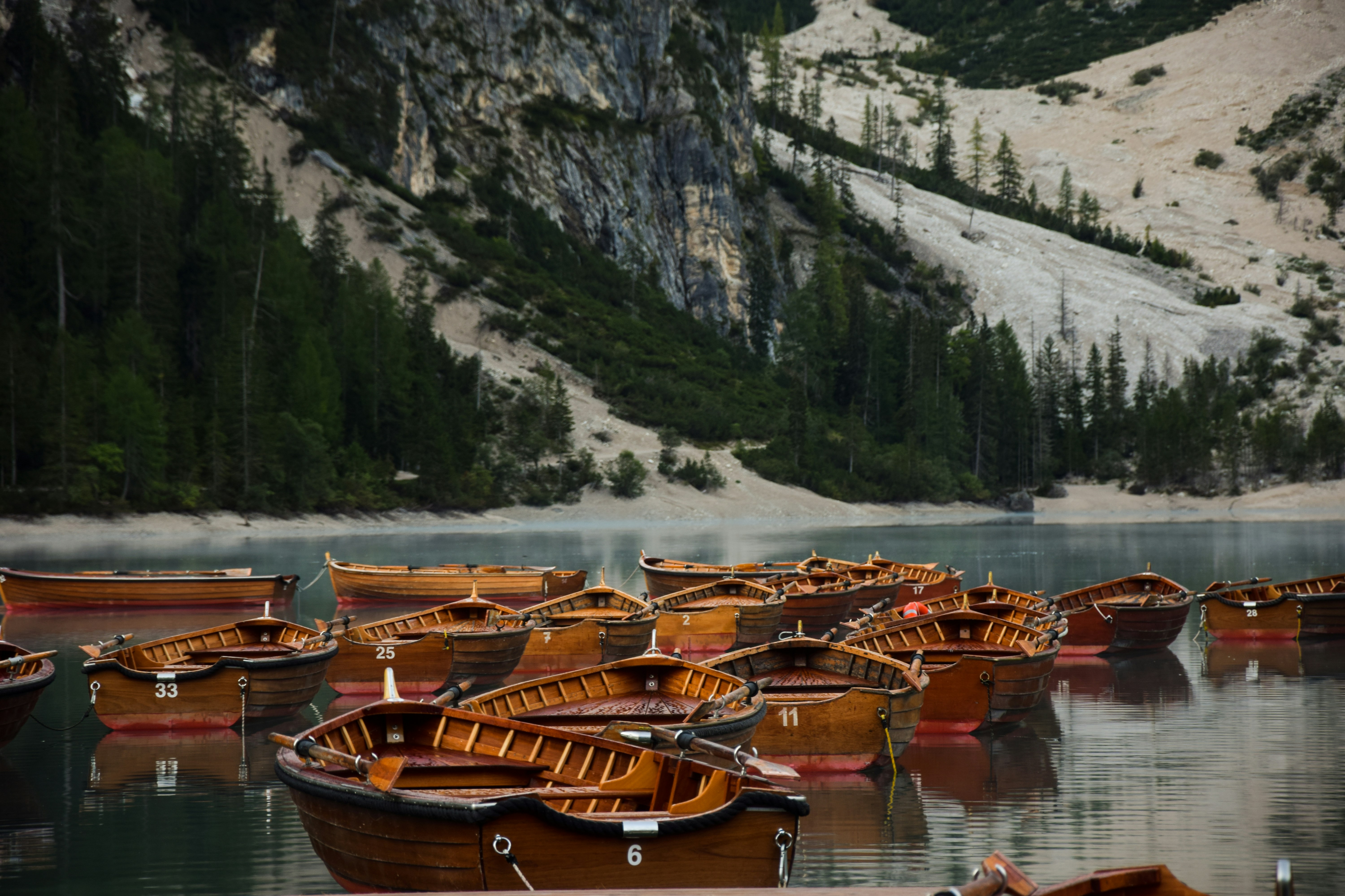 Alpine Fleet: Wooden Rowboats Quietly Rest on a Mountain Lake