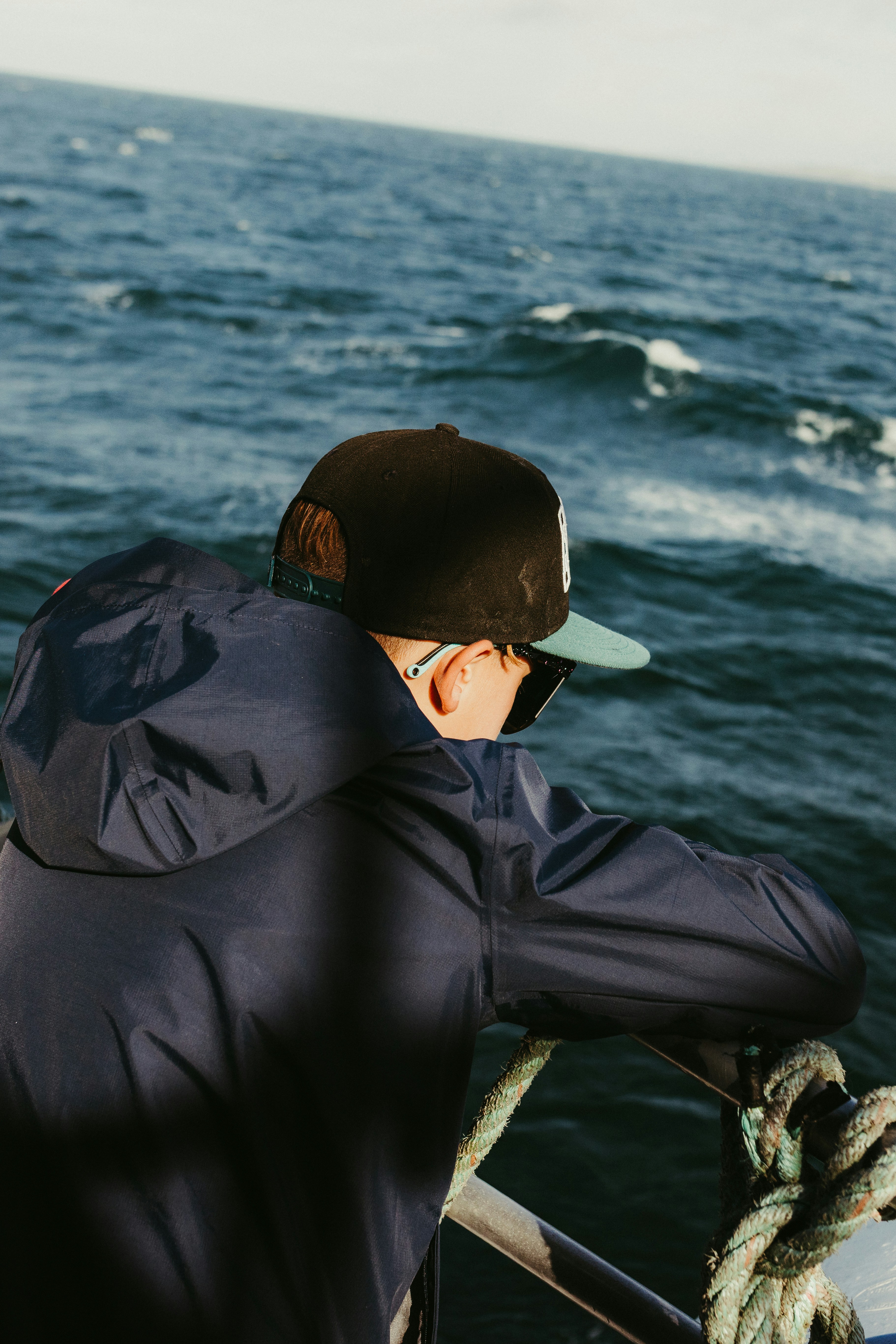 On the Rail: A Seafarer's Quiet Vigil at Rough Seas