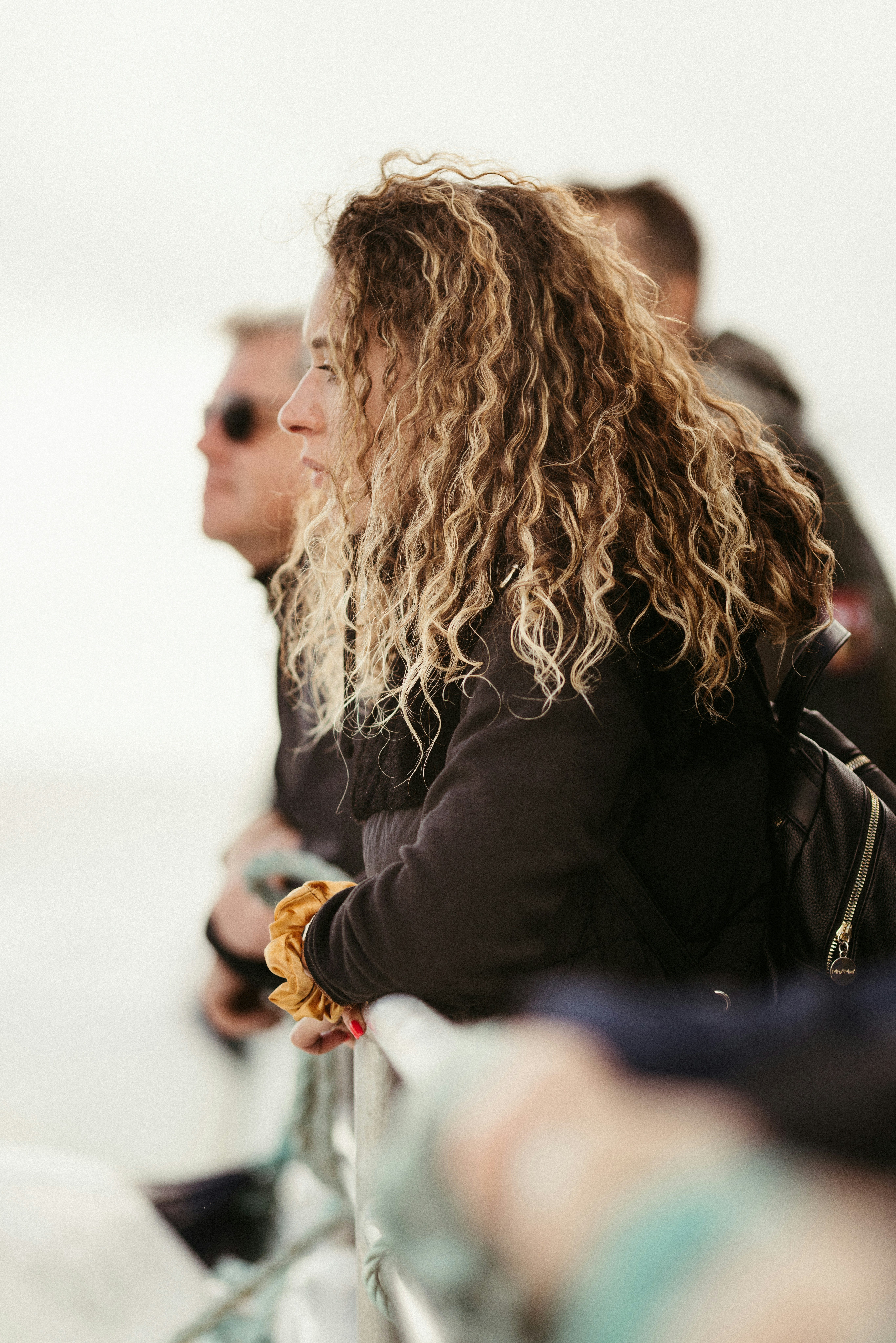 Harbor Gaze: Profile of a Curly-Haired Observer at the Rail