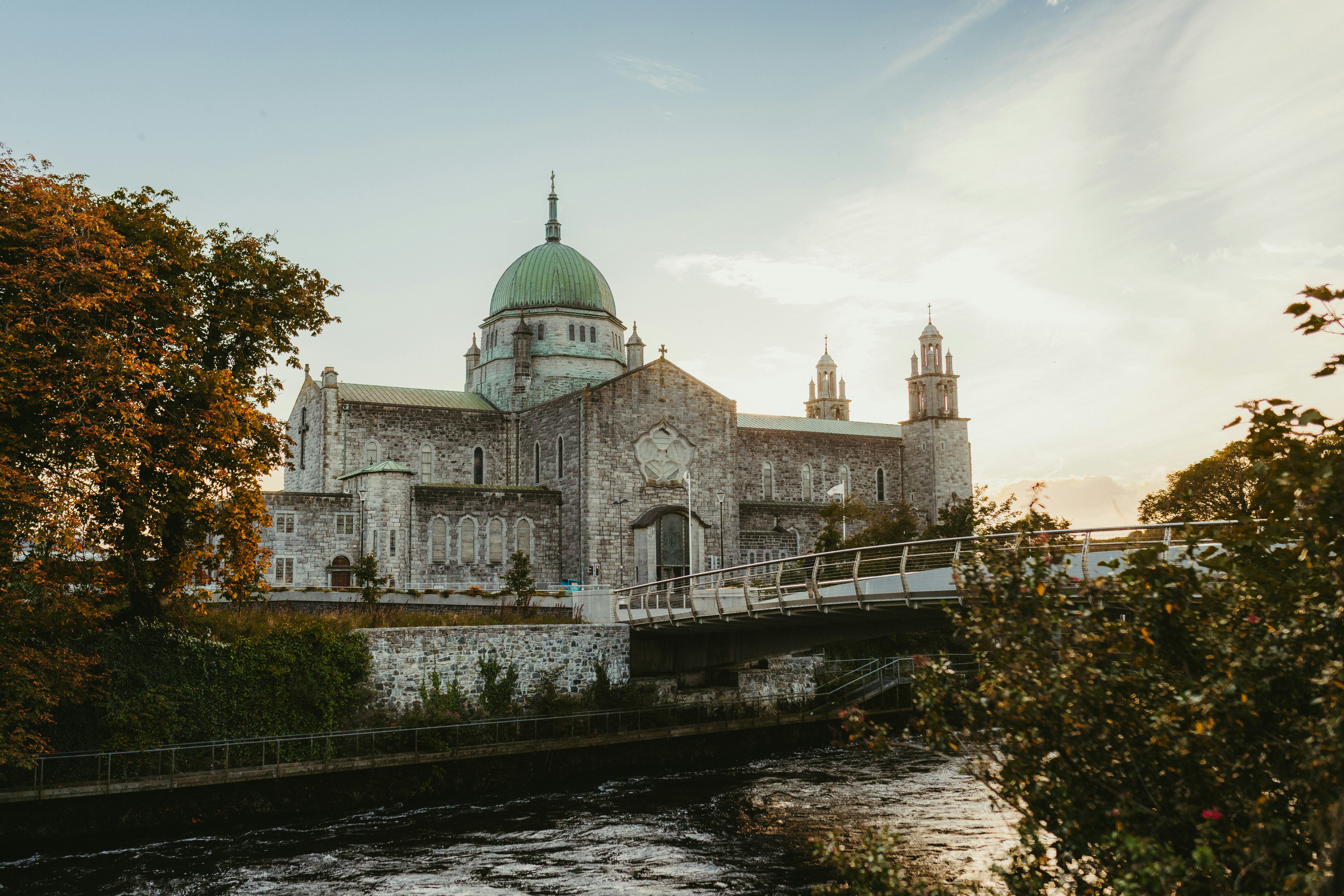 Green-Domed Cathedral by the River: Autumn Light on Stone and Bridge