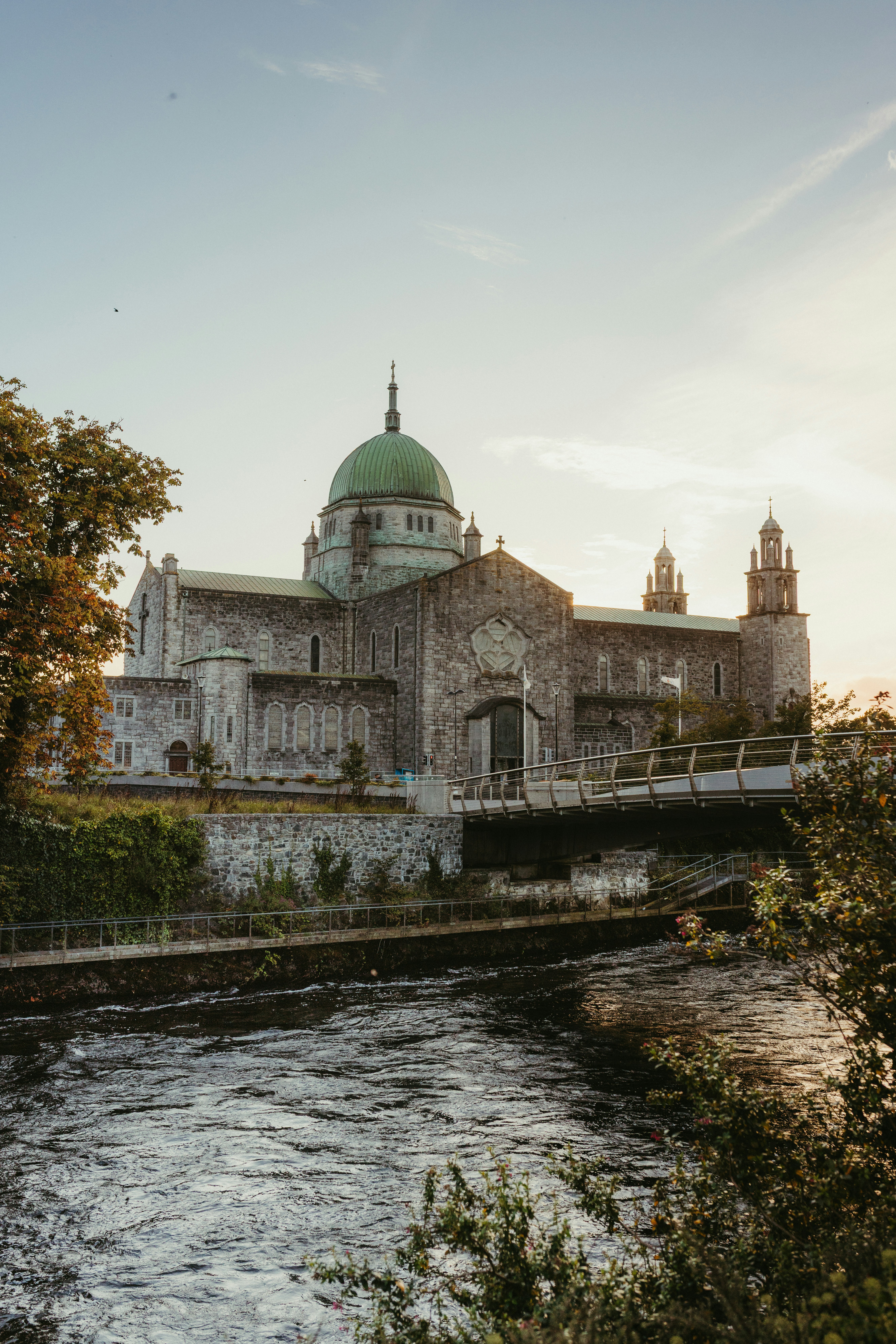Emerald Dome Cathedral Framed by Riverside Bridge at Golden Hour