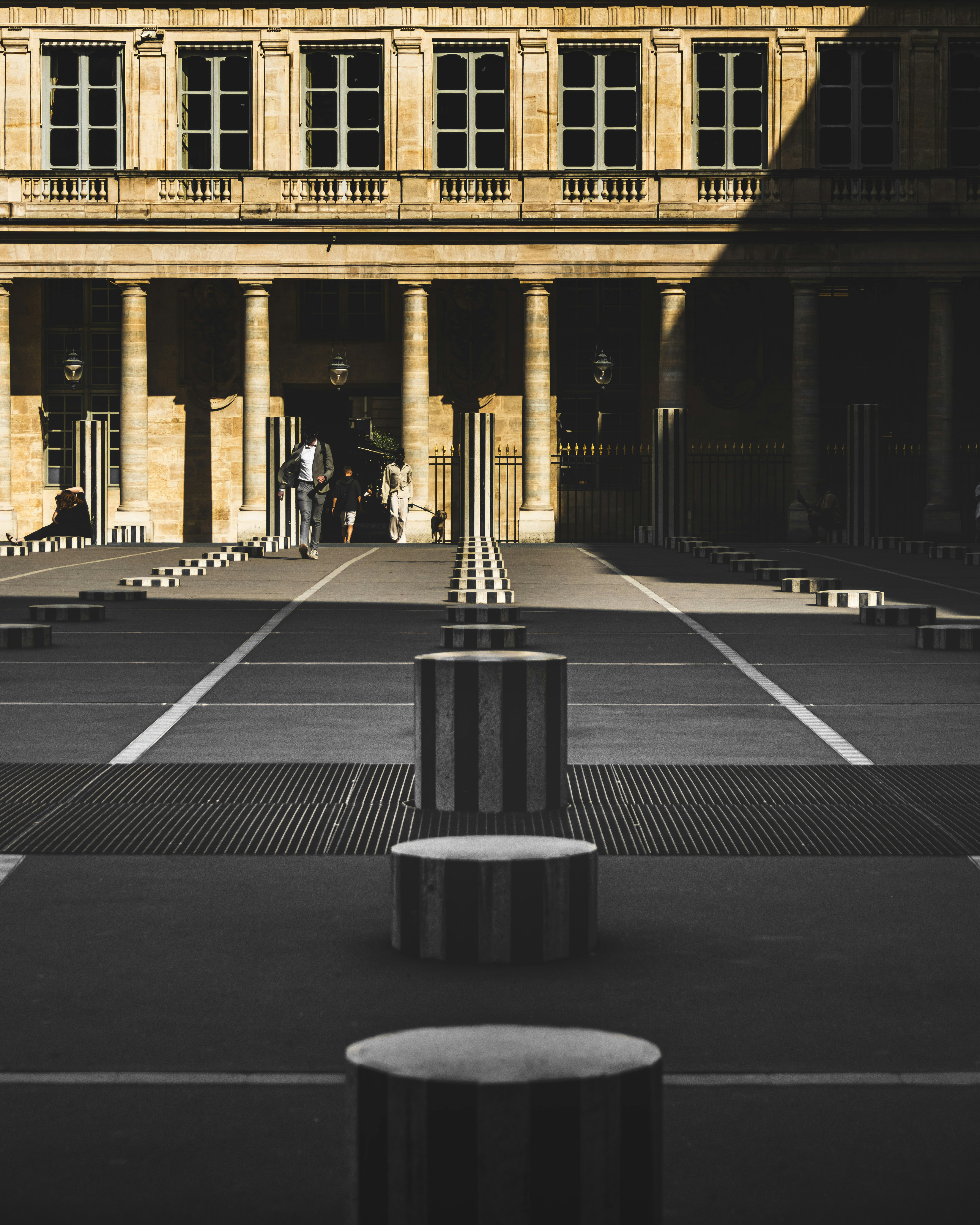 Line of Light: Central Bollards Guide the Eye to a Sunlit Portico
