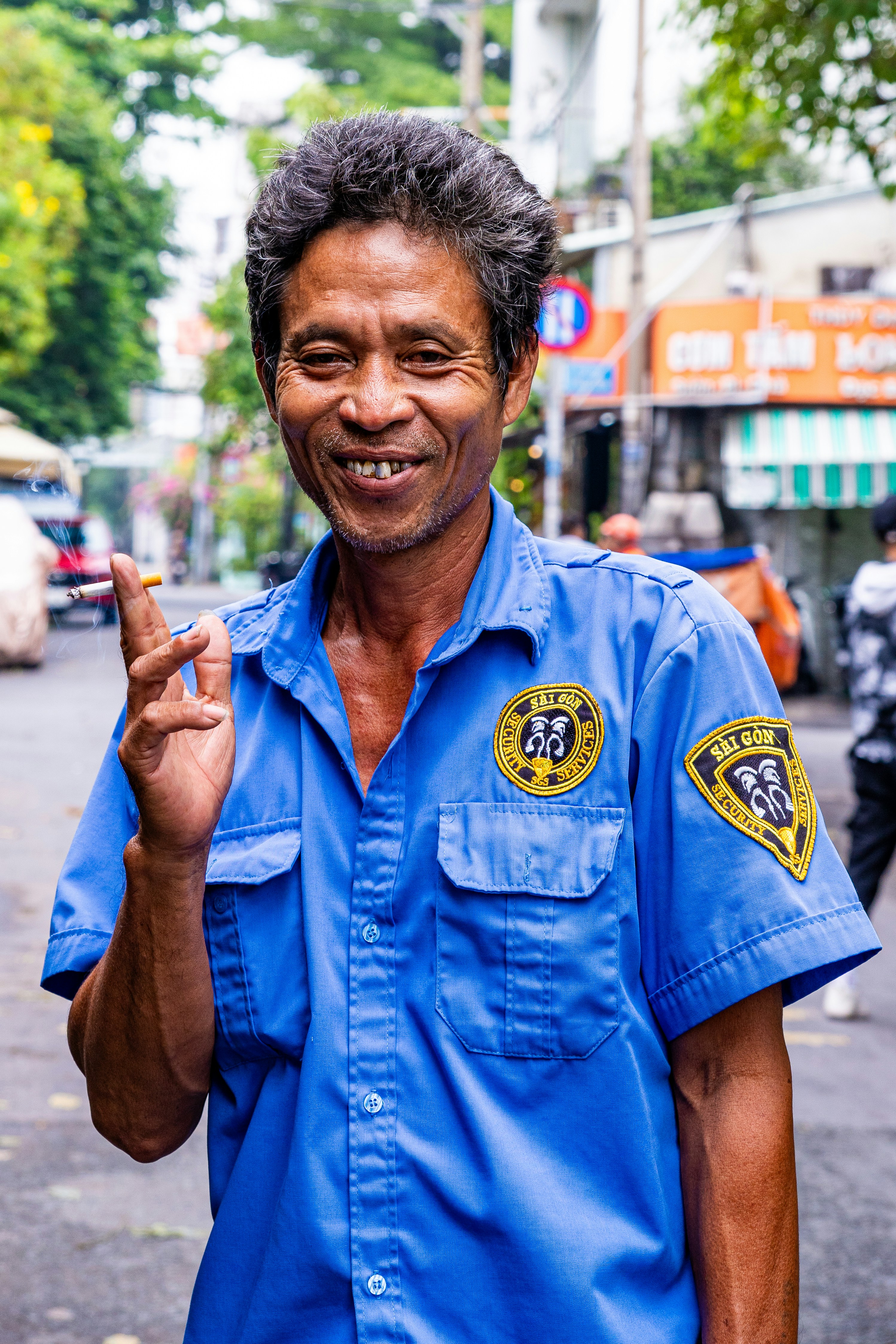 Blue Uniform on a Bustling Saigon Street: A Friendly Moment