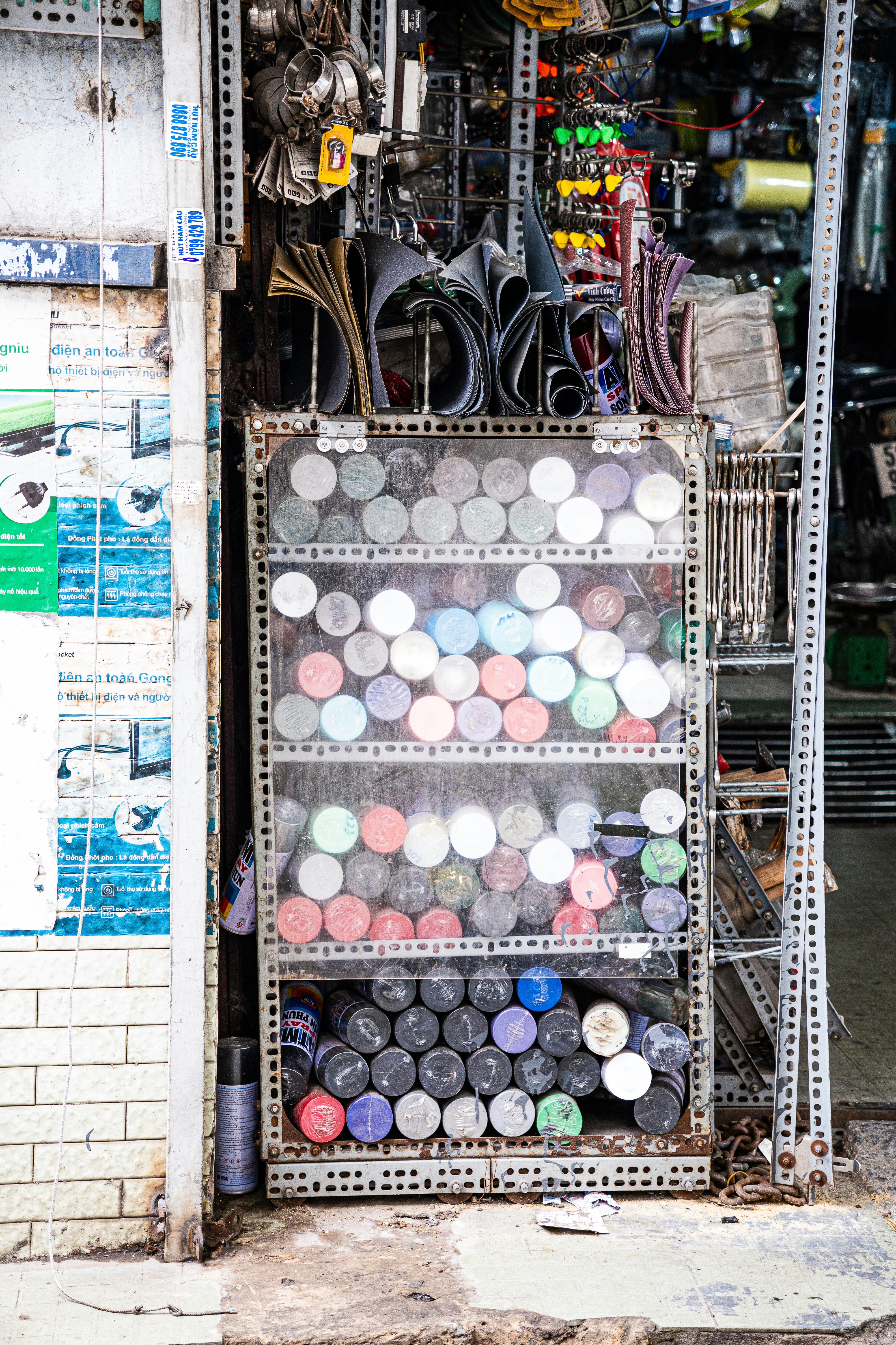 Neon Palette in a Metal Cabinet: Spray Cans at a Streetfront Workshop