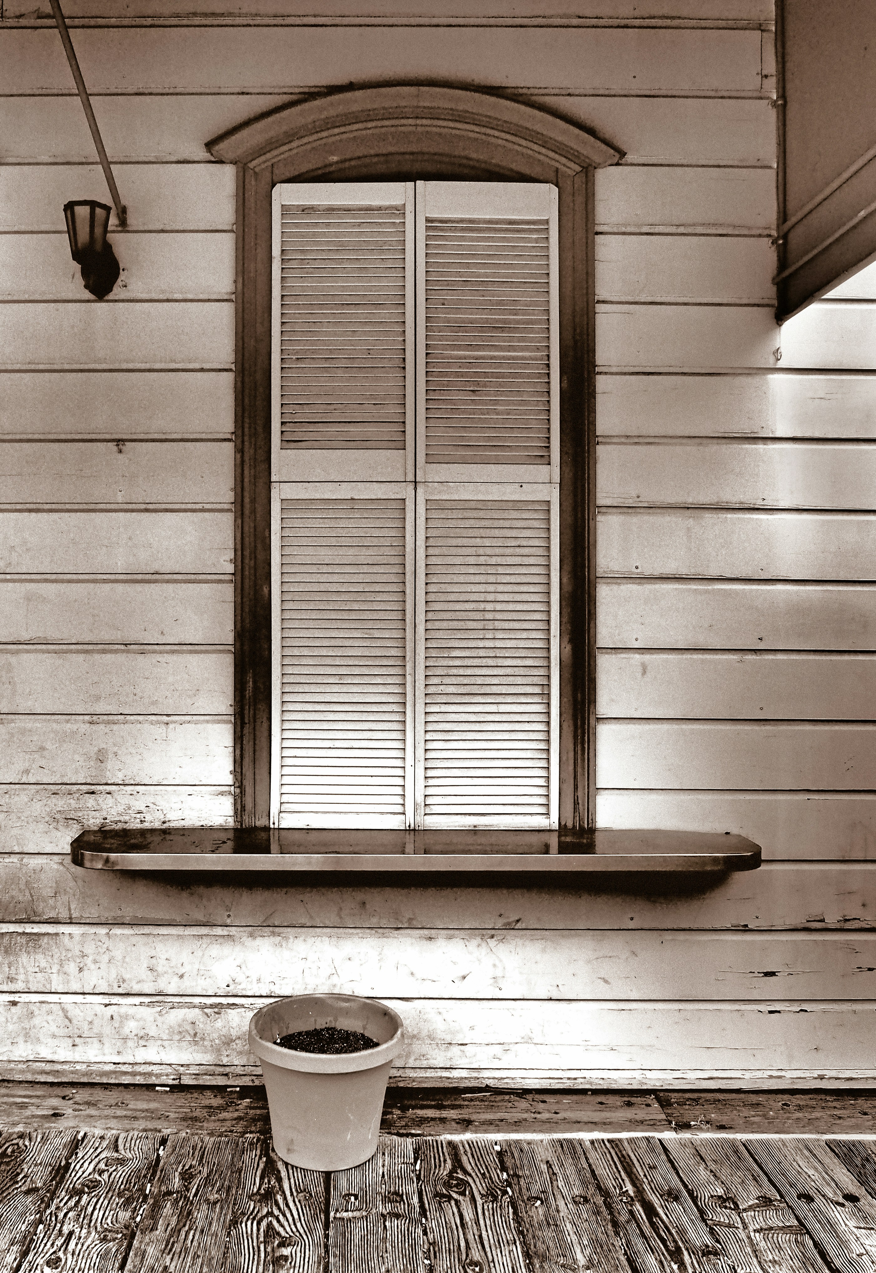 "Terminal" --- An old-time train station ticket window in sepia.