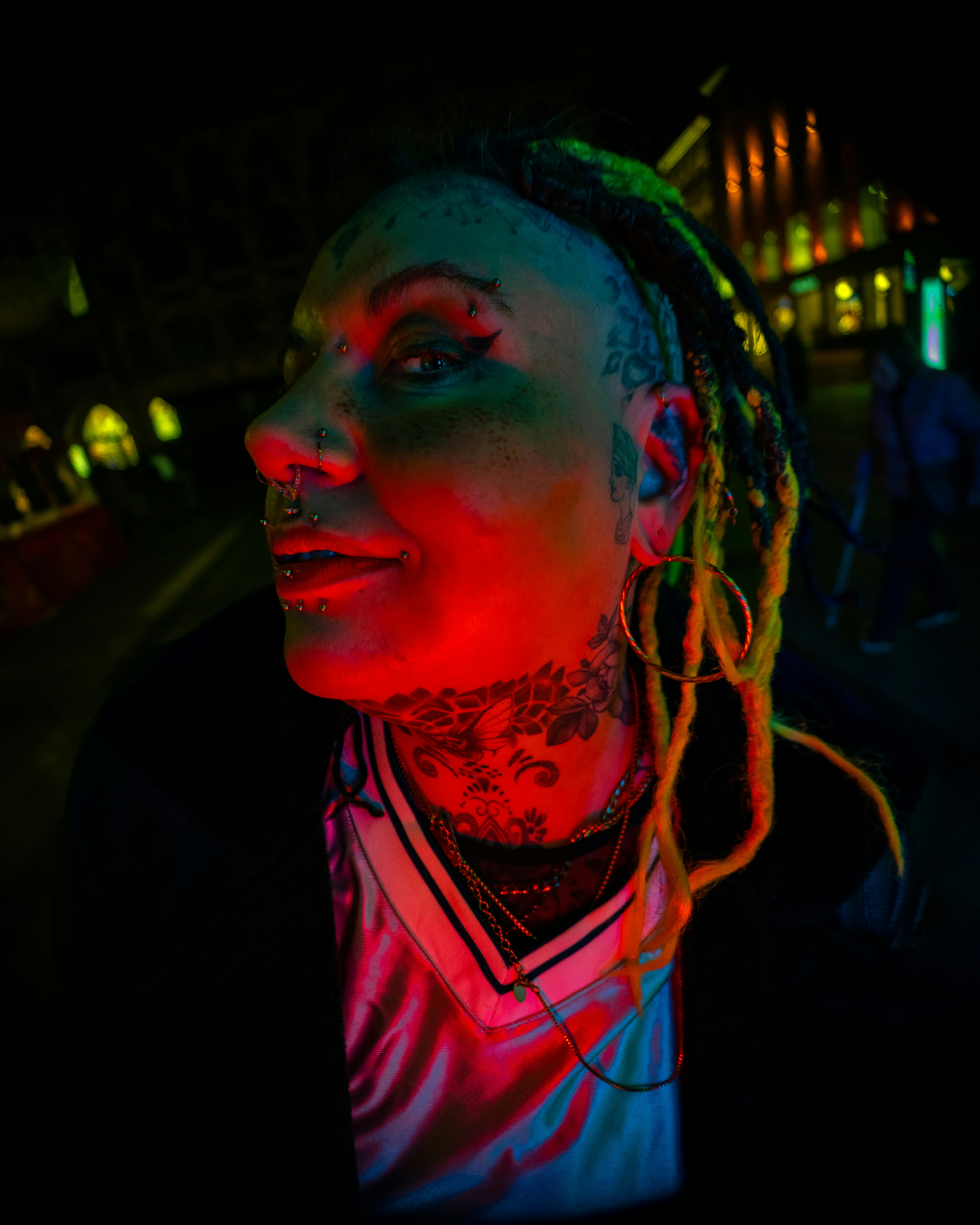 Person with tattoos and piercings illuminated by red light photo – Free ...