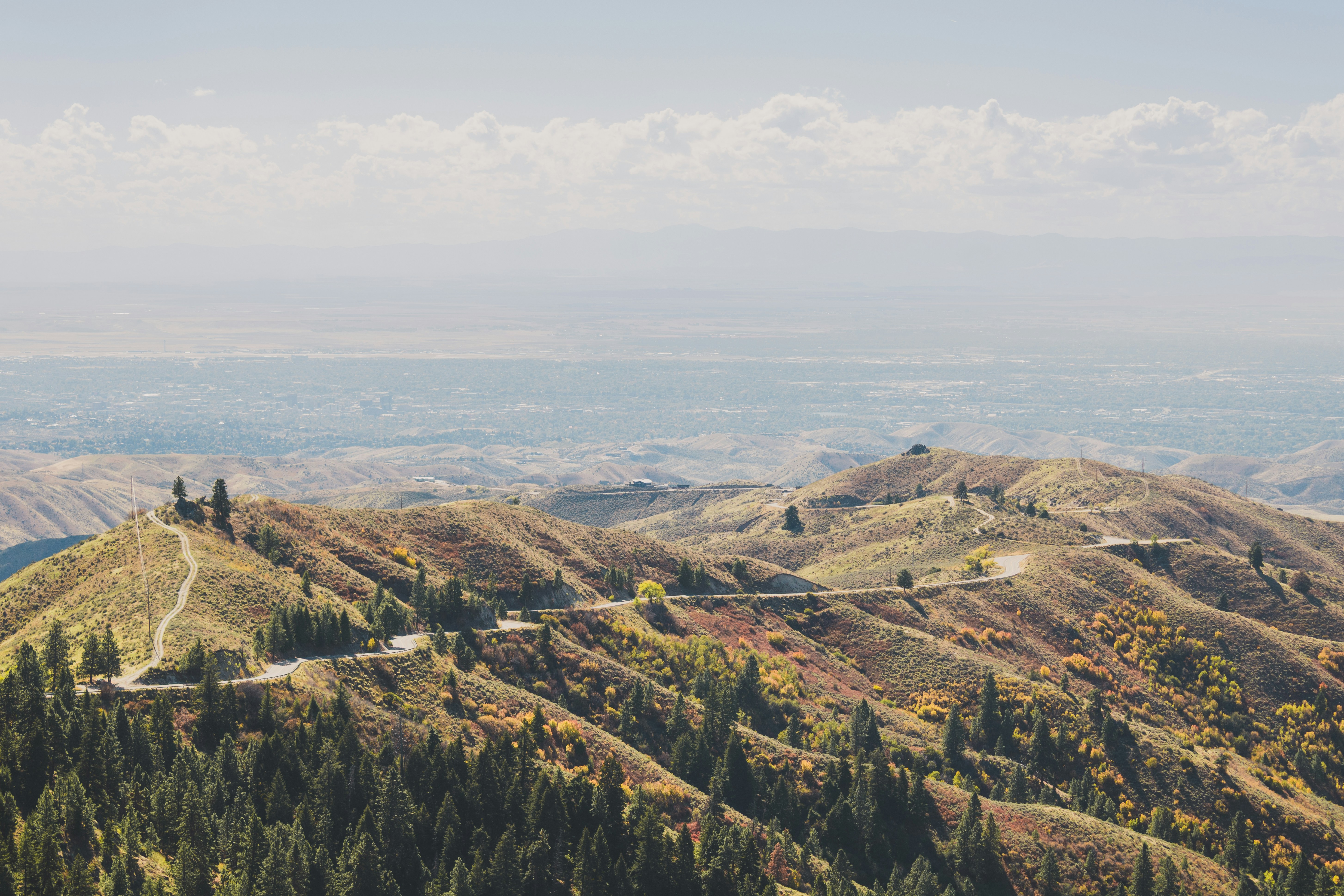 Winding Ribbon Across Golden Hills at Distant Horizon