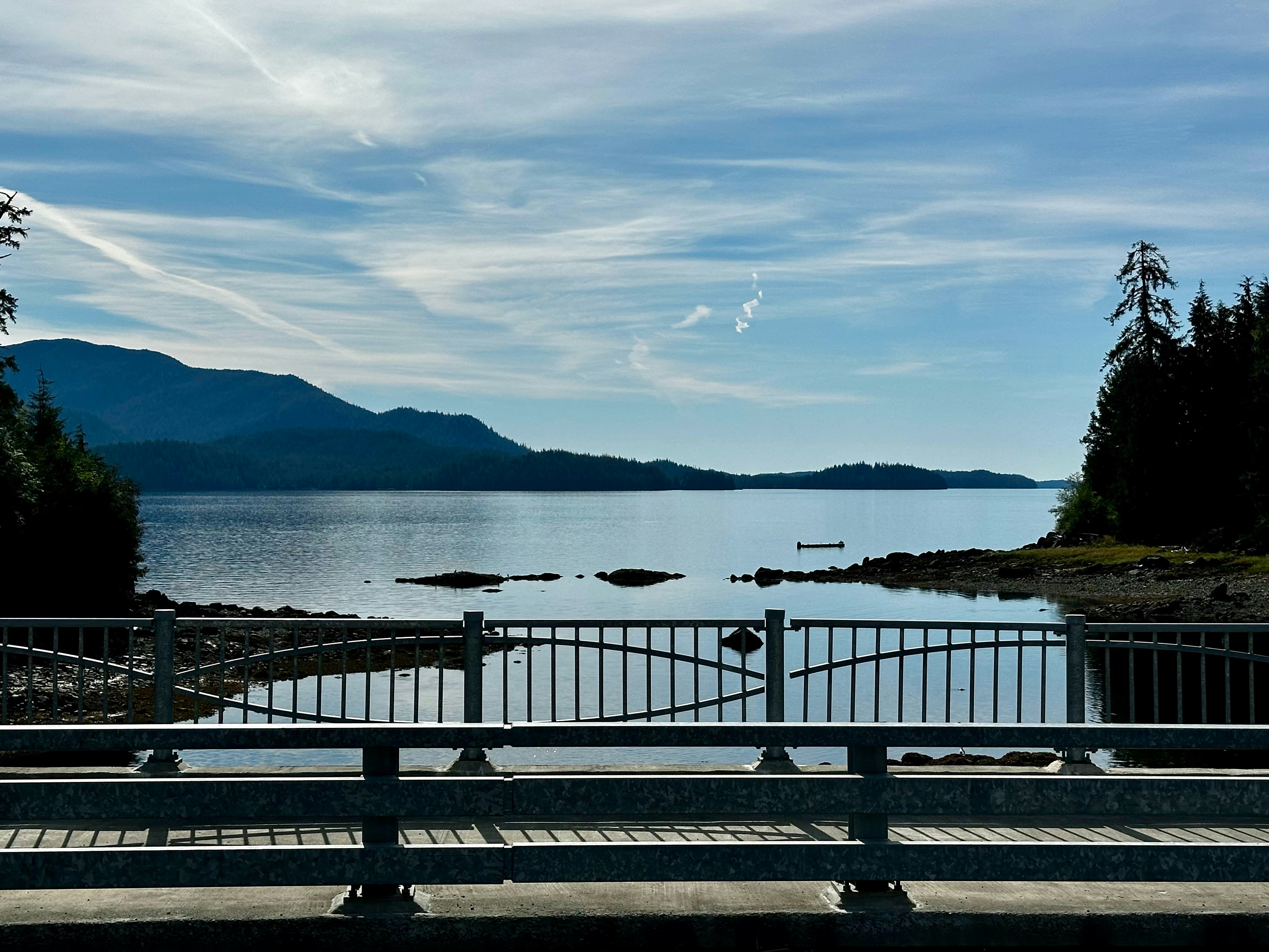 Rail Over the Fjord: A Quiet Lakeside Vista Framed by Distant Peaks