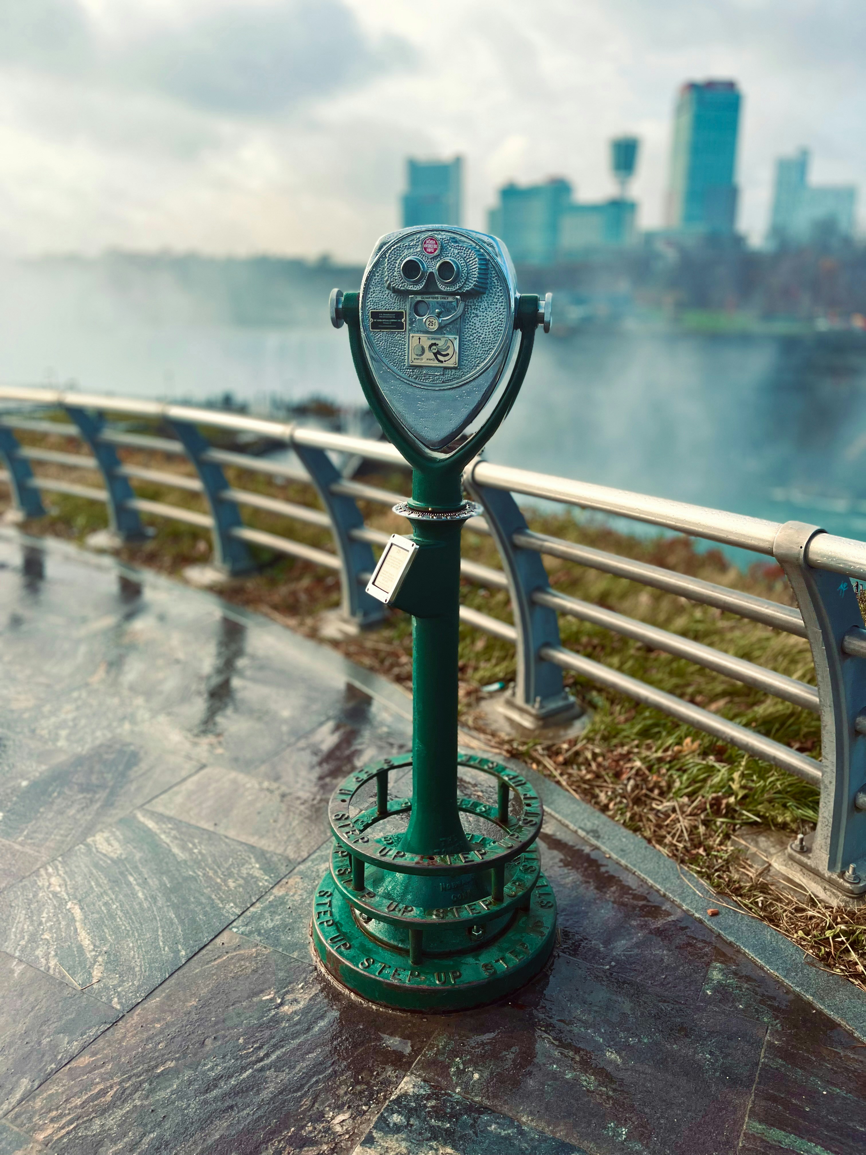 Coin-Operated Viewfinder Over a Misty Waterfront