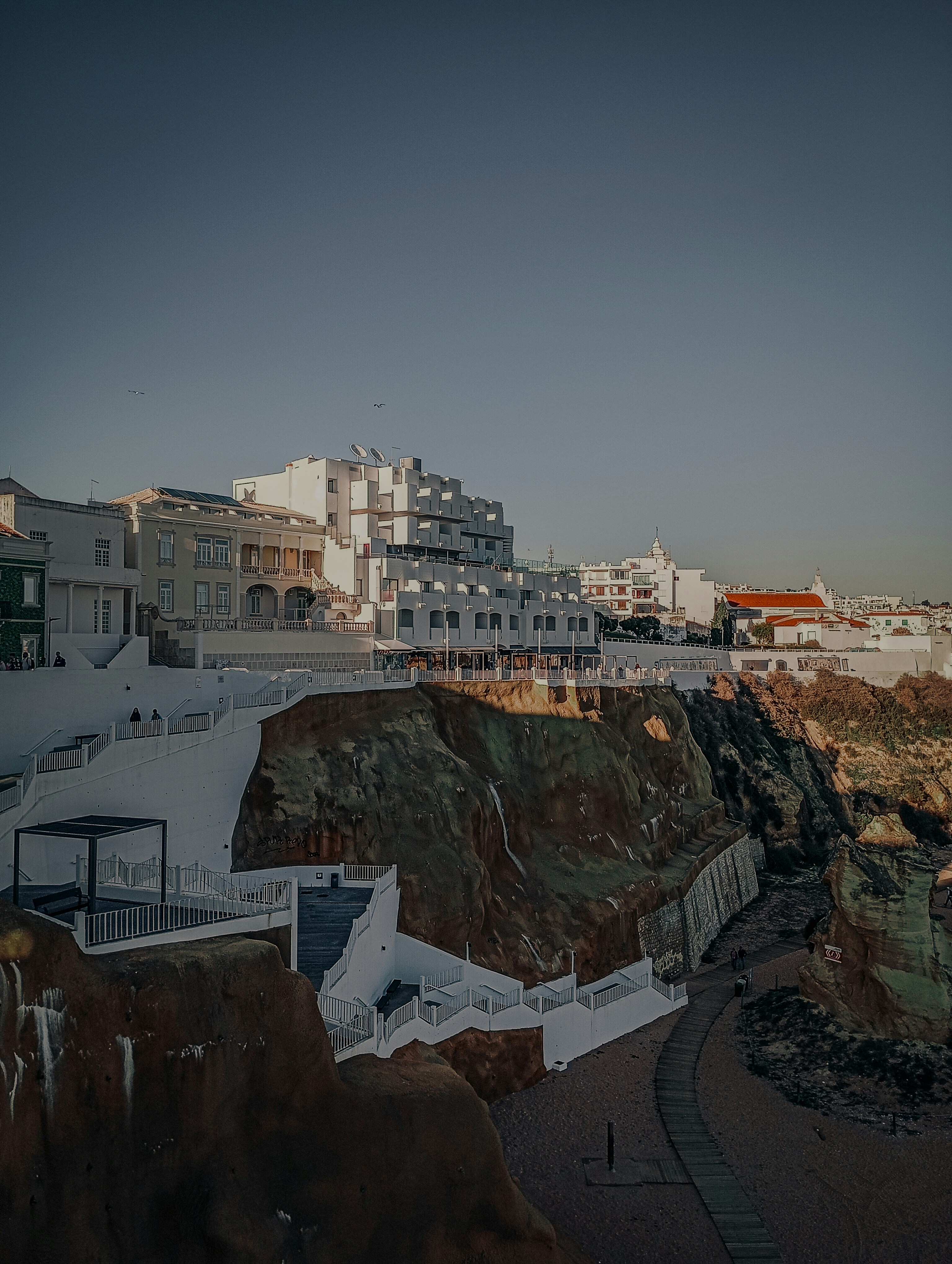 Cliffside Whitewashed Village Beneath a Wide Blue Sky