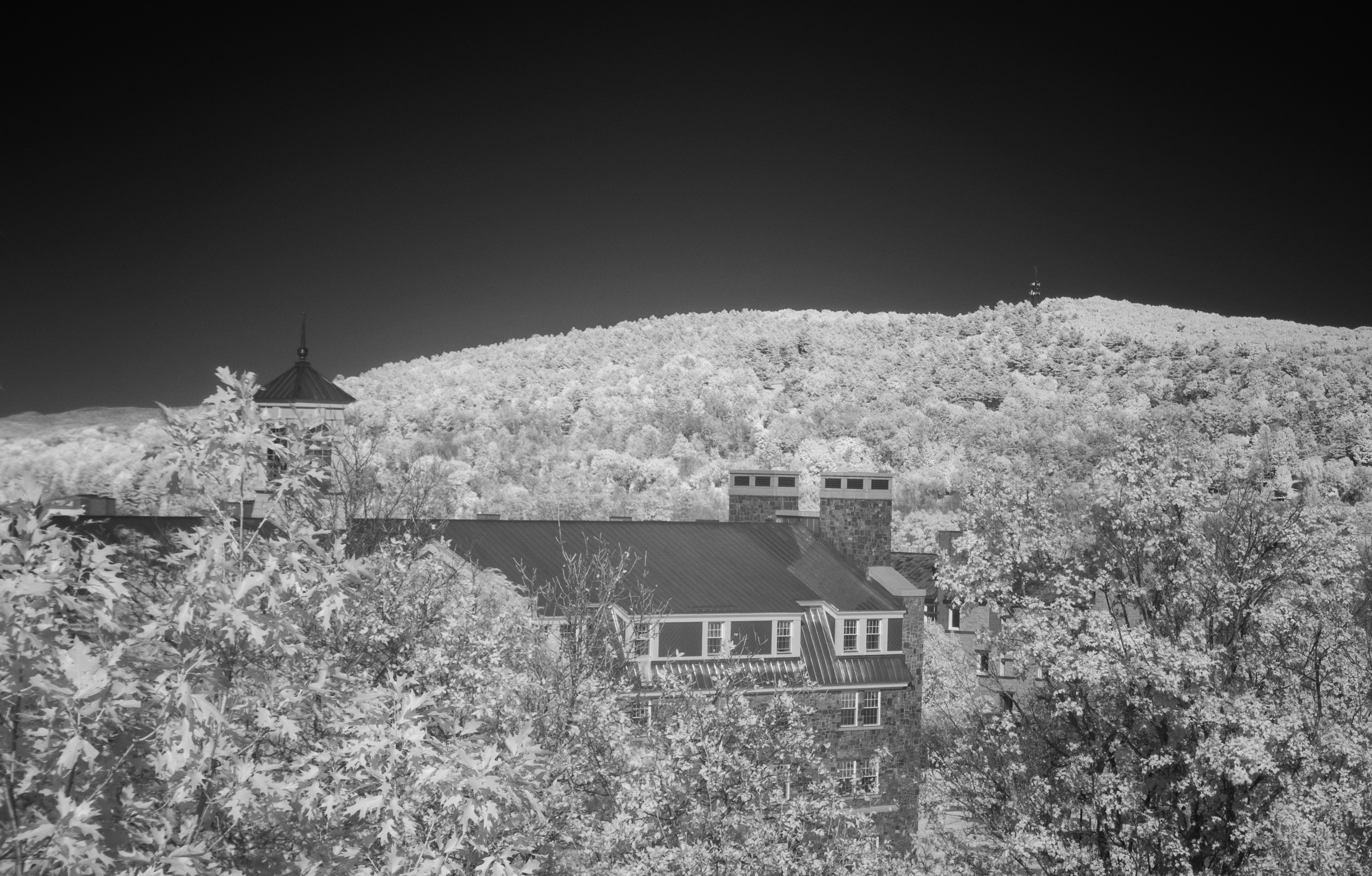 Infrared Quietude: Brick Facades Beneath a Luminous Hill