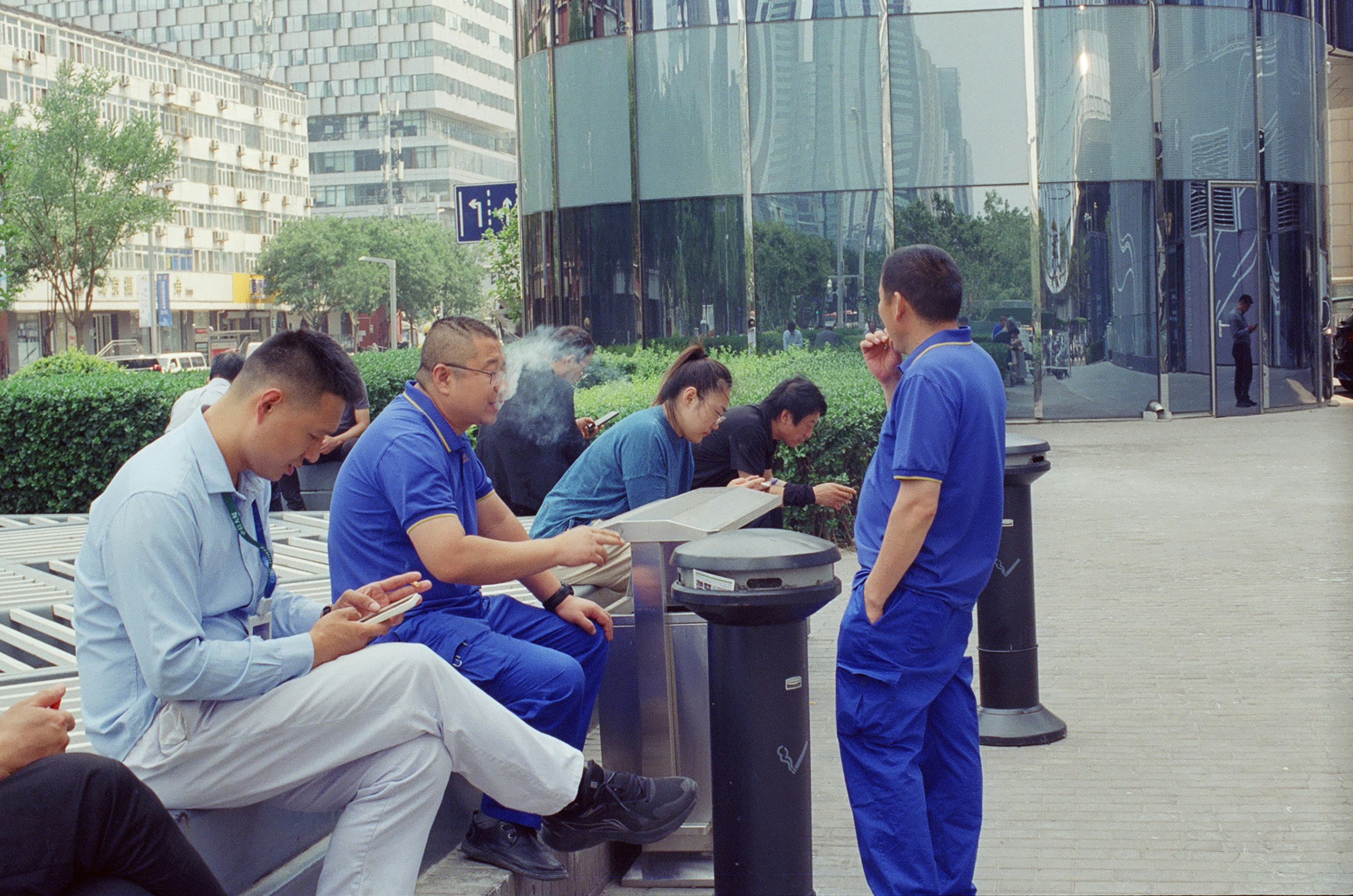 Workers in blue uniforms taking a break outside. photo – Free Cityscape ...
