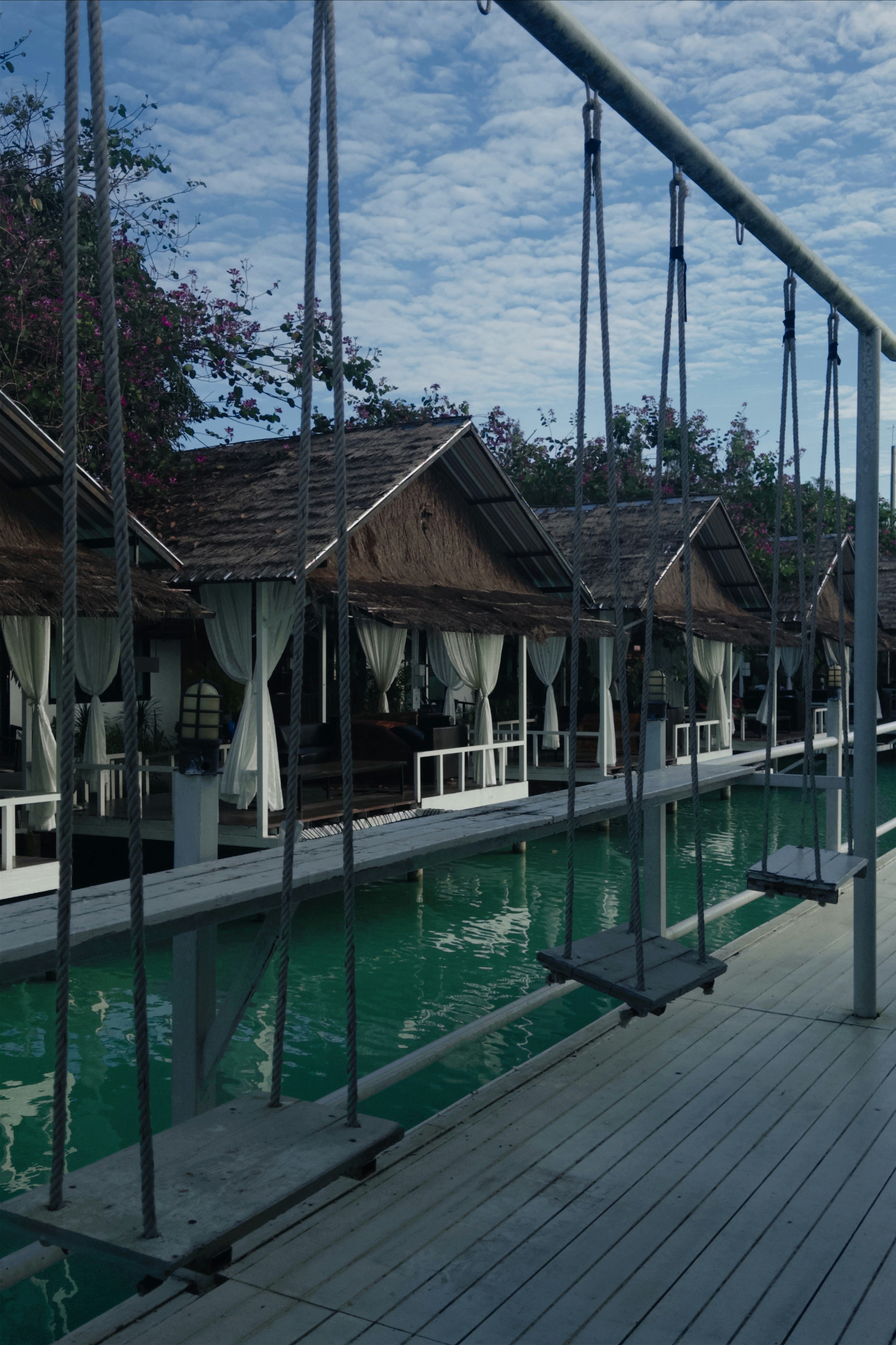 Turquoise Canal Overwater: Swing Bridges and Thatched Bungalows