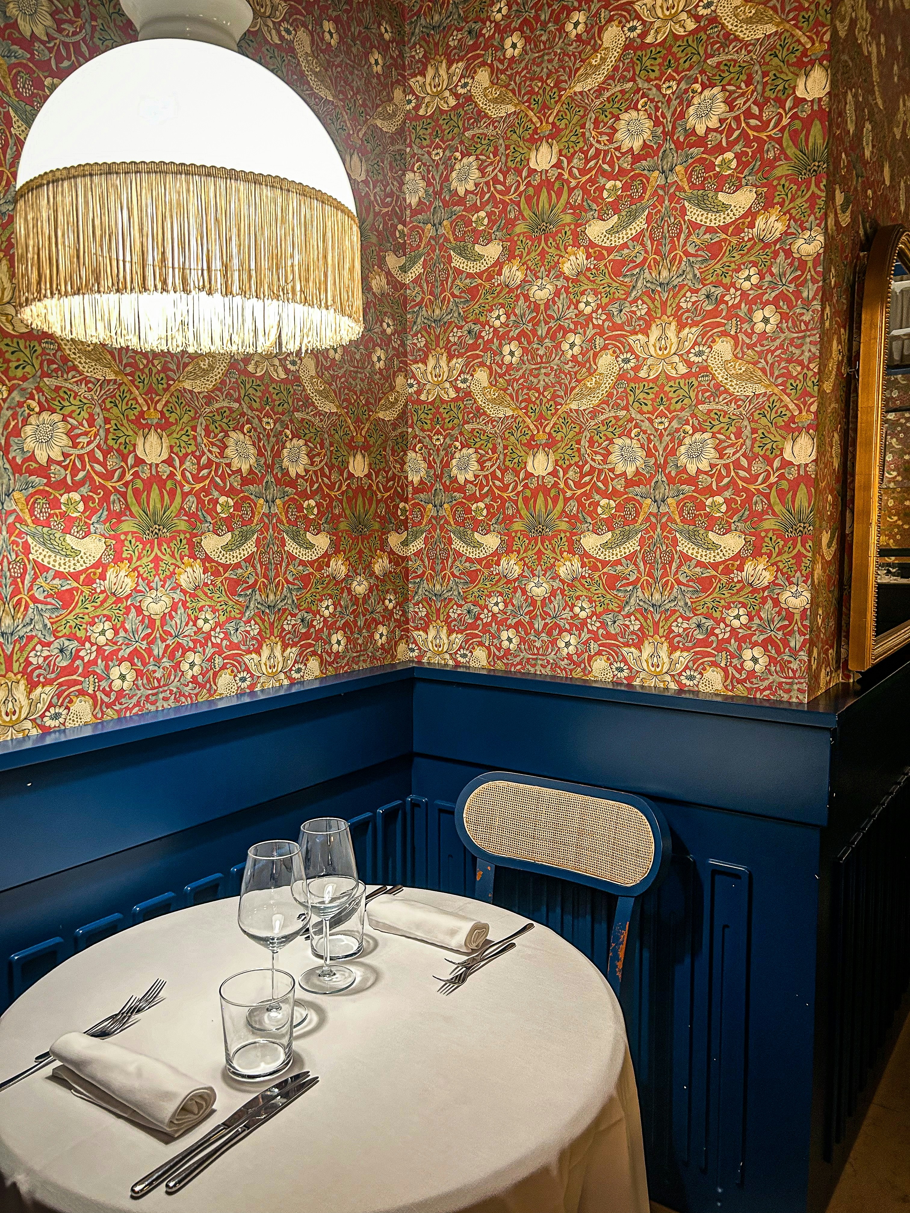 Intimate Dining Corner: Damask Walls, Blue Wainscoting, and a Pristine Table Setting
