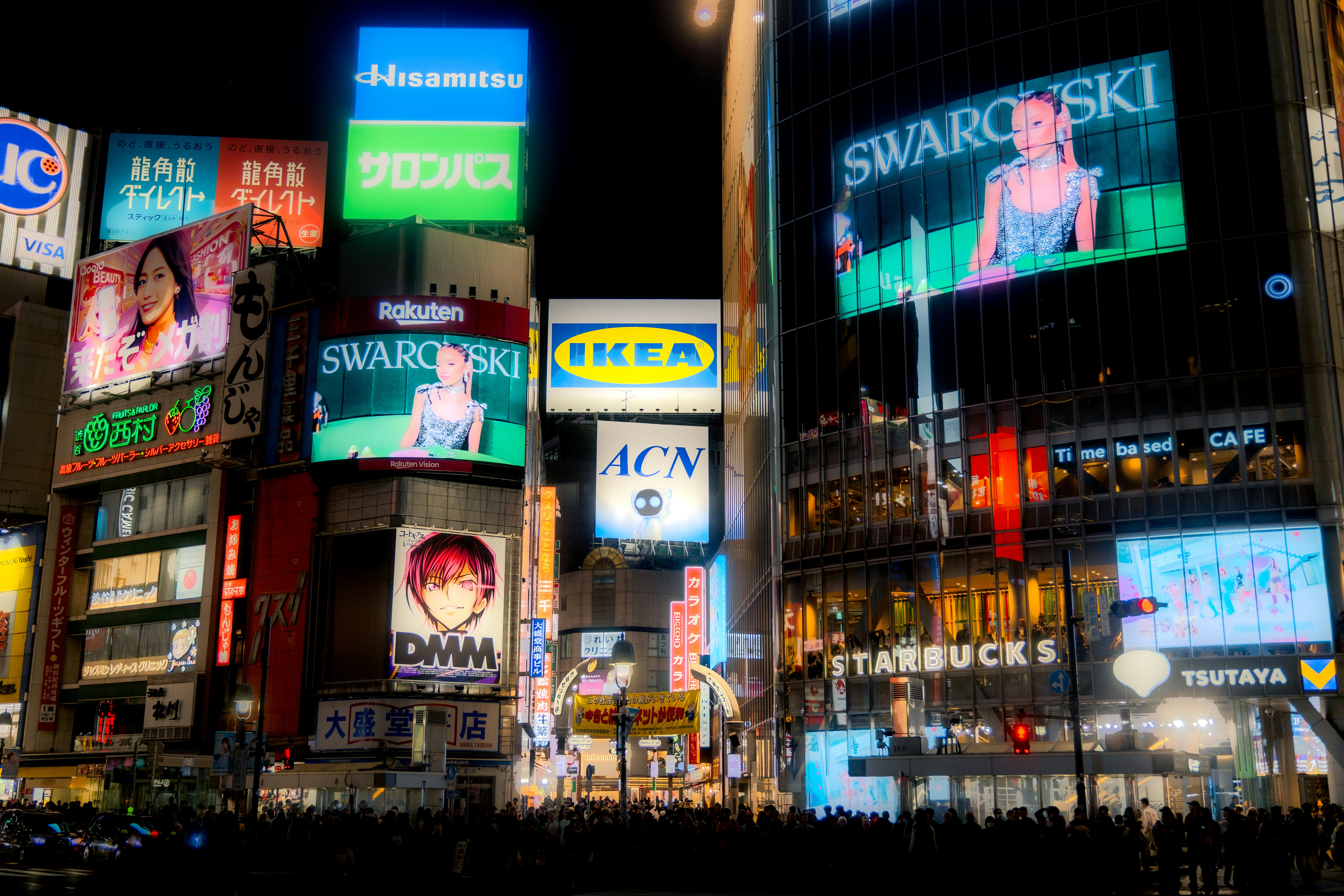 Neon Mosaic Over Shibuya Crossing: Night of Giant Screens and Crowds