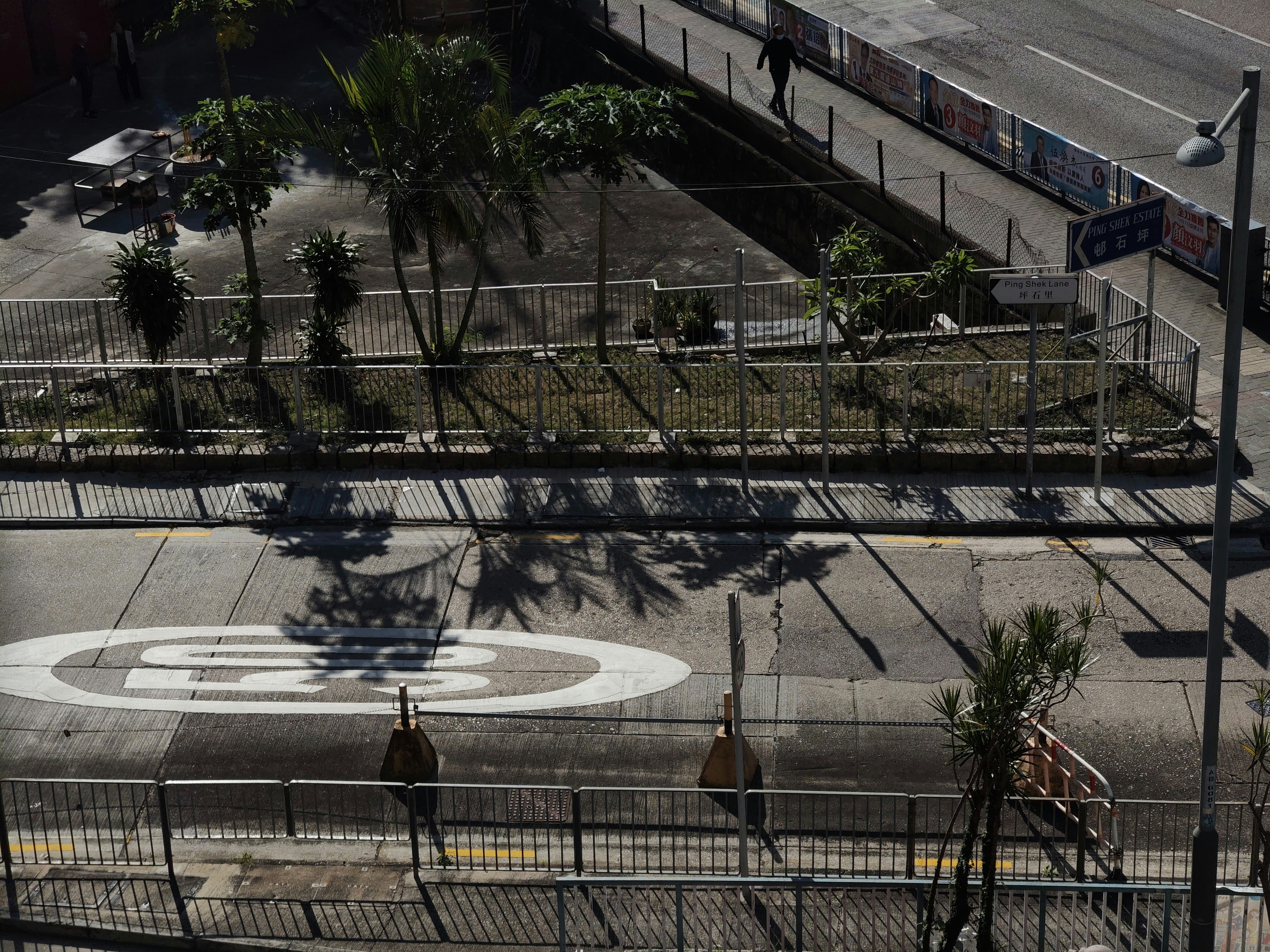Helicopter landing pad with palm tree shadows.