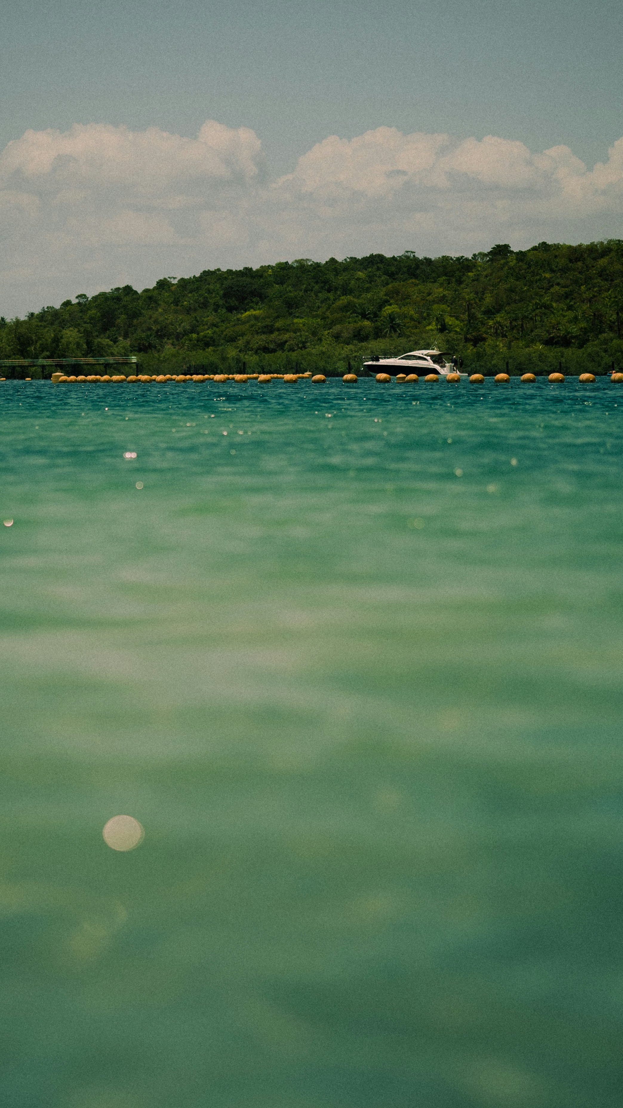 Horizon Run Over Turquoise Waters: A Lone Boat