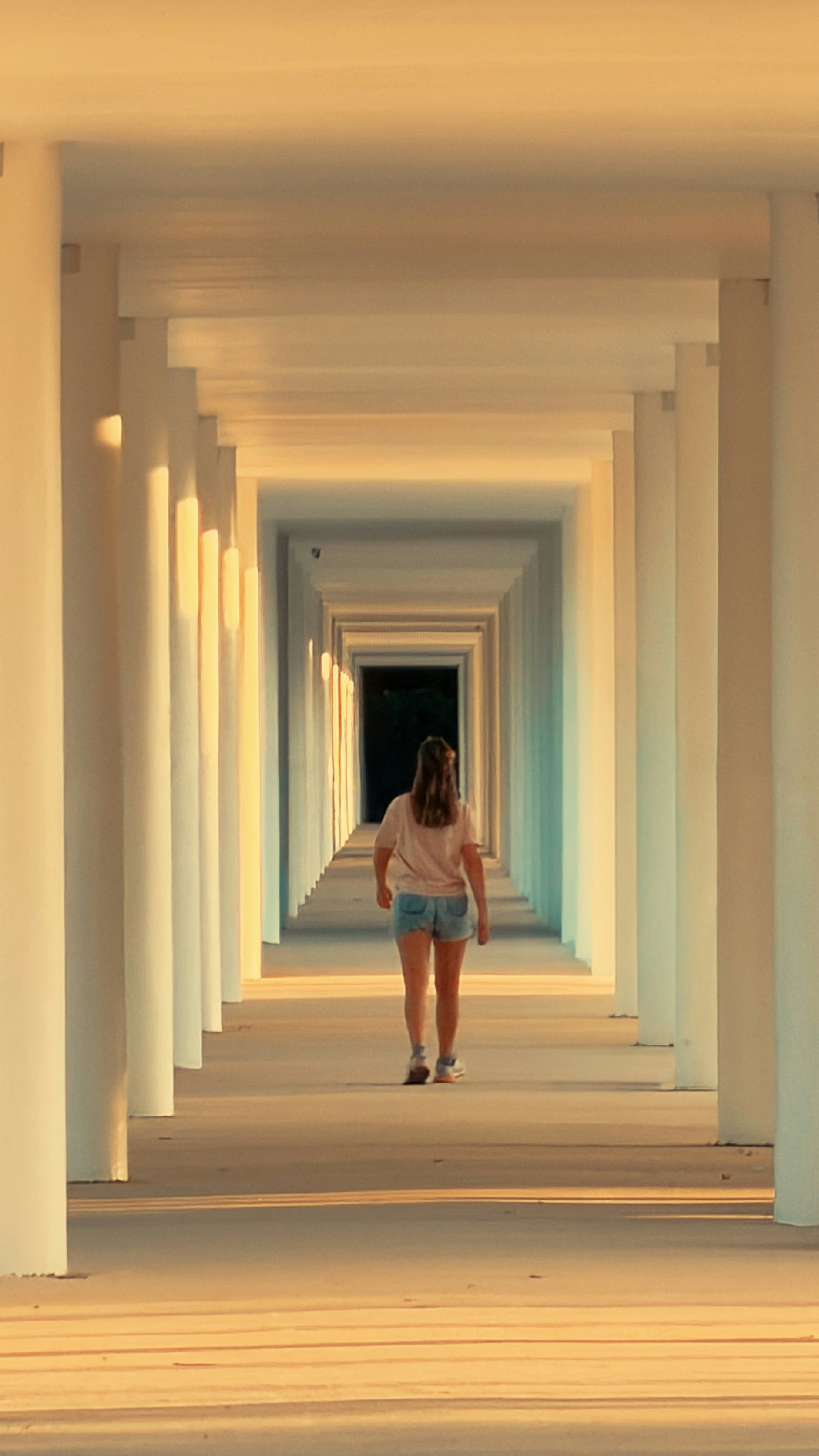 Golden Colonnade: A Solo Walk Toward the Distant Arch