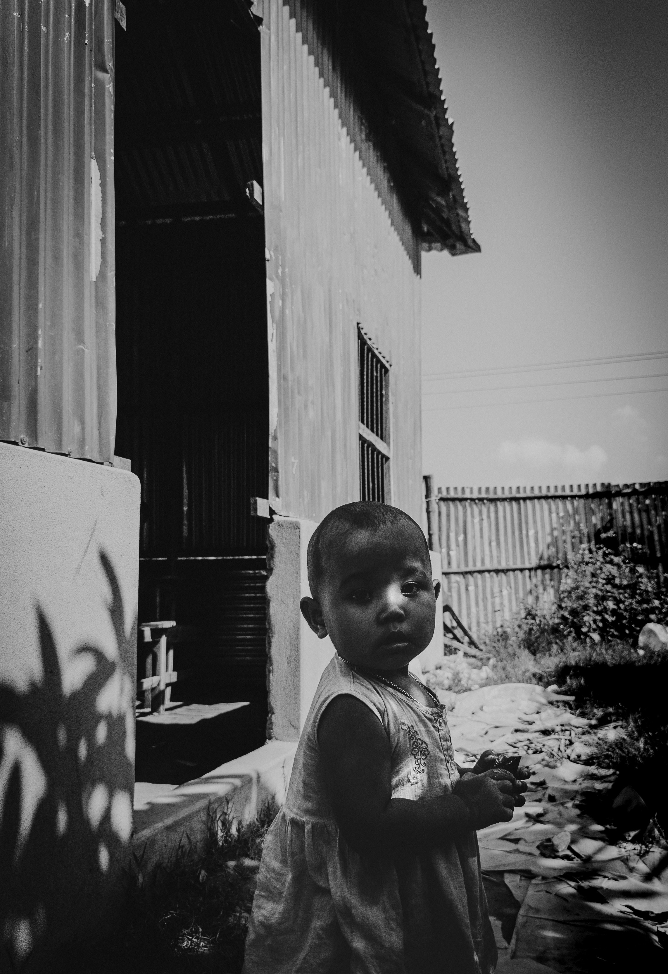 Child in doorway: a quiet, sunlit moment at the threshold