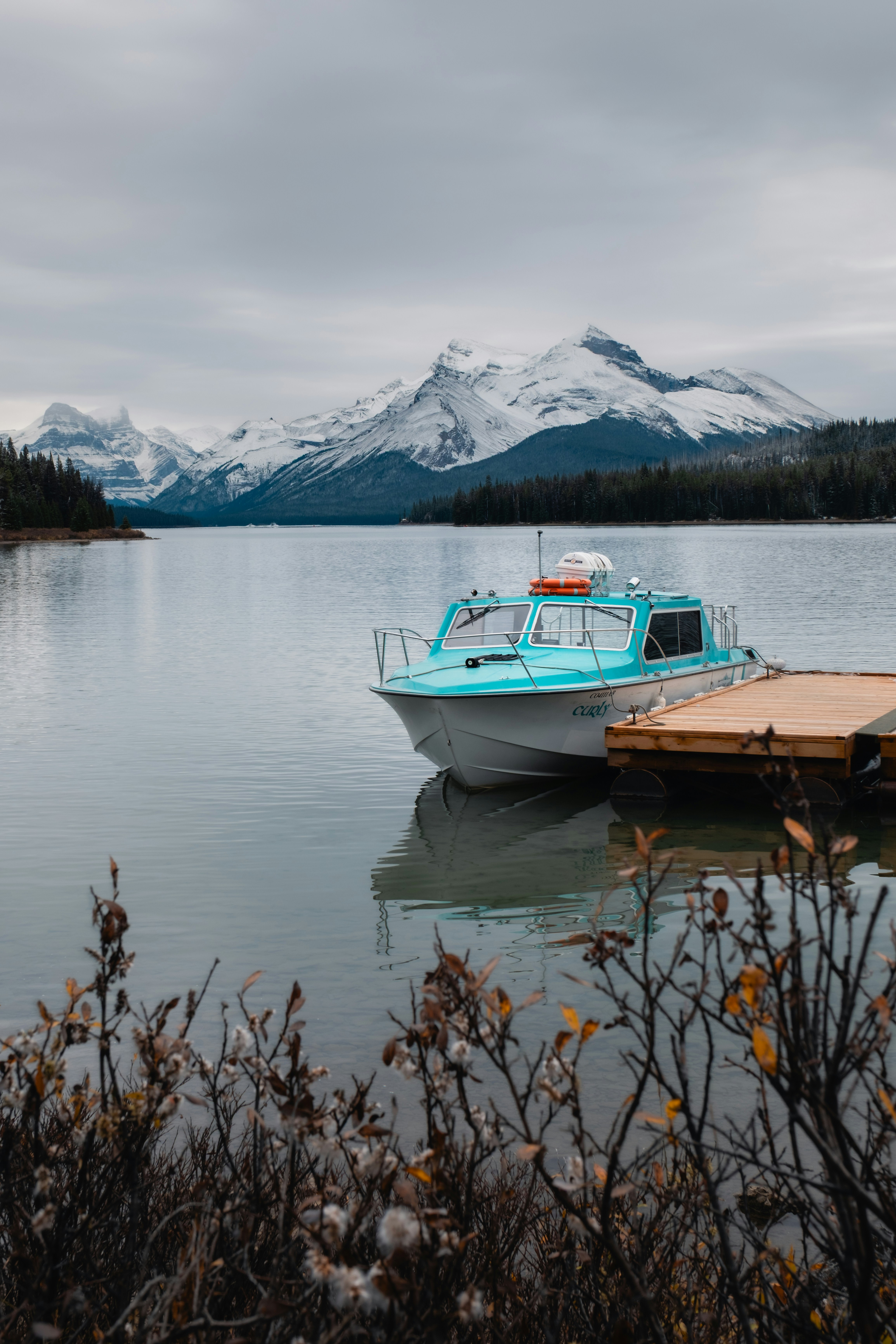 Azure Tender at a Glassy Alpine Lake Framed by Snowbound Peaks