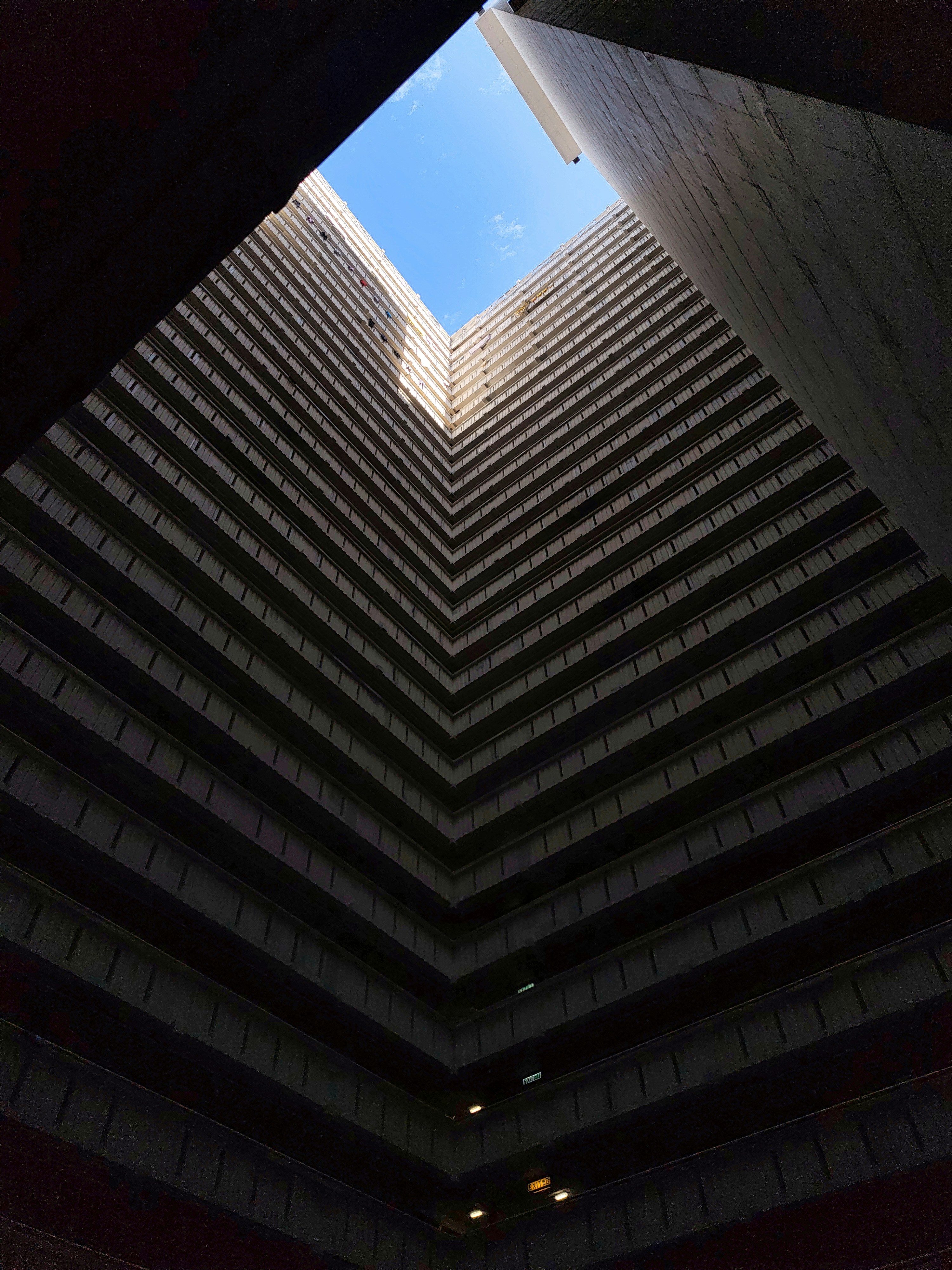 Looking up at a building's geometric concrete structure